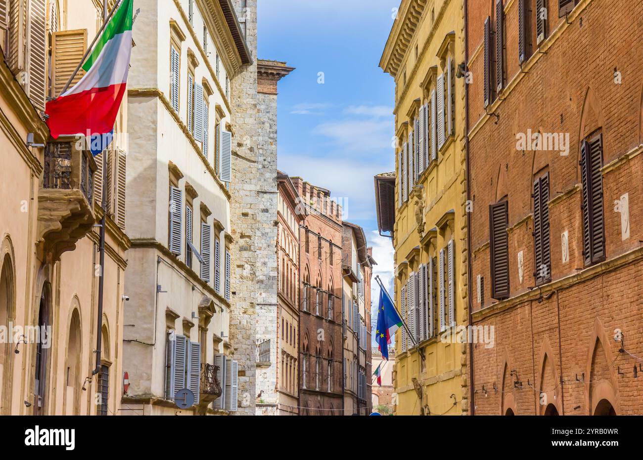 Flags on the facades of old houses in historic city Siena, Italy Stock ...