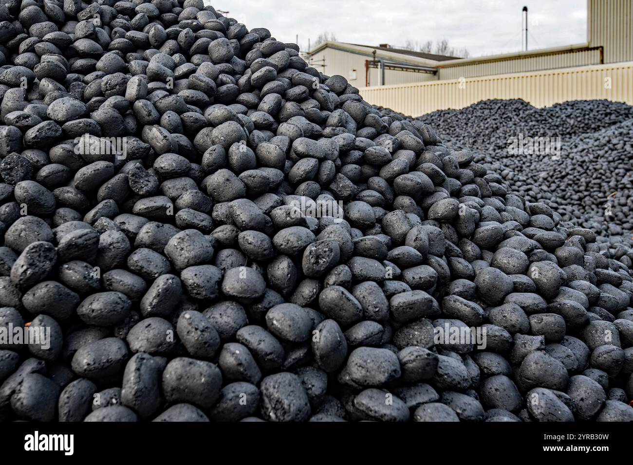 Pile of regularly shaped coal briquettes in coal merchant's yard Settle ...