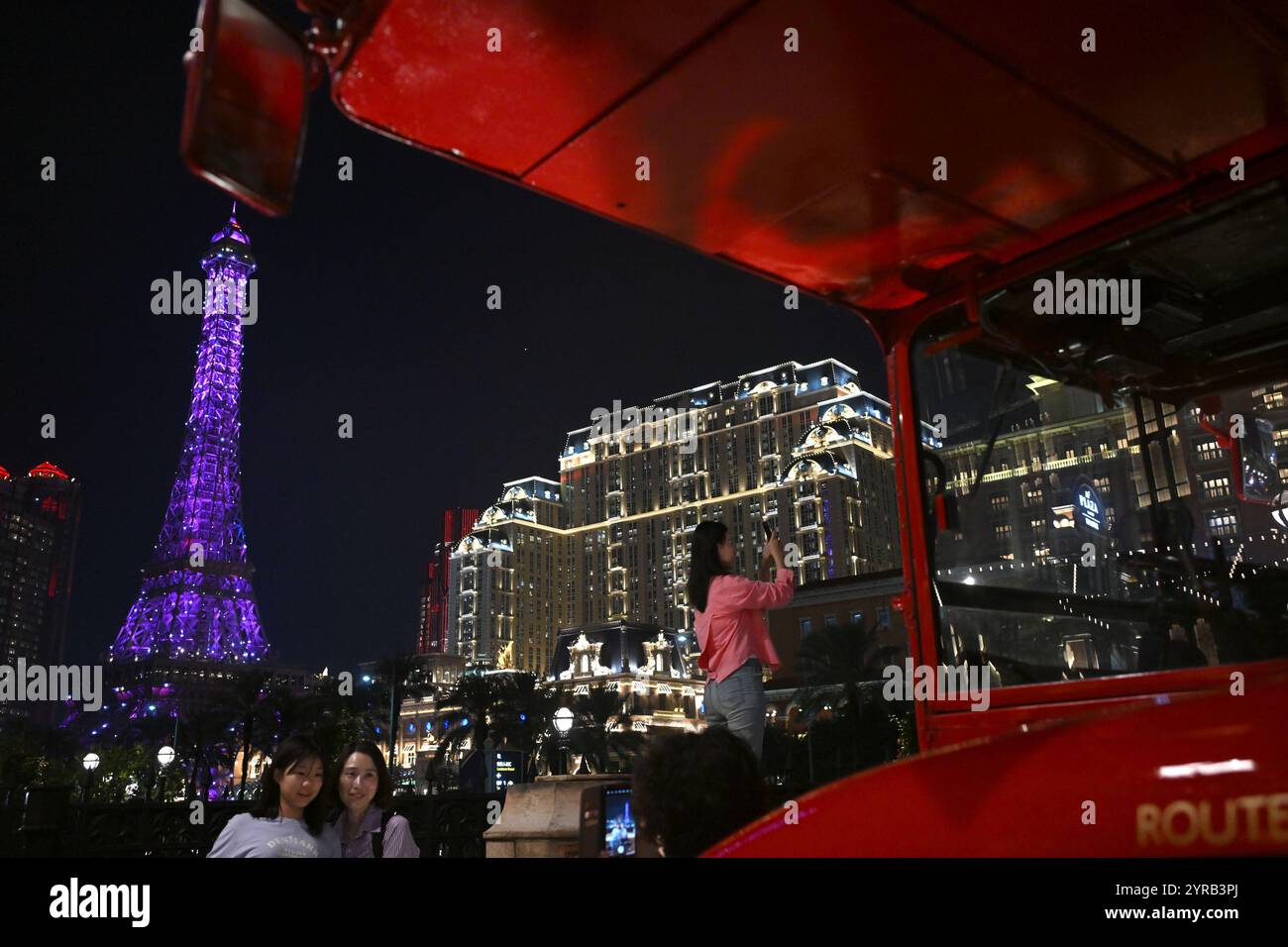 Macao. 17th Nov, 2024. People take photos on the street in south China ...