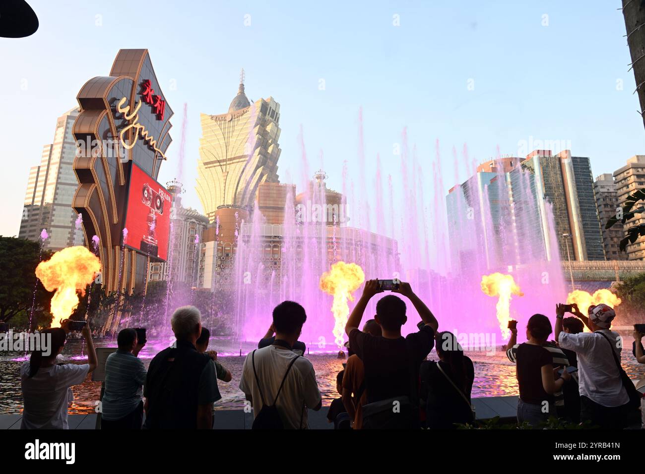 Macao. 17th Nov, 2024. People take photos of a fountain in south China ...