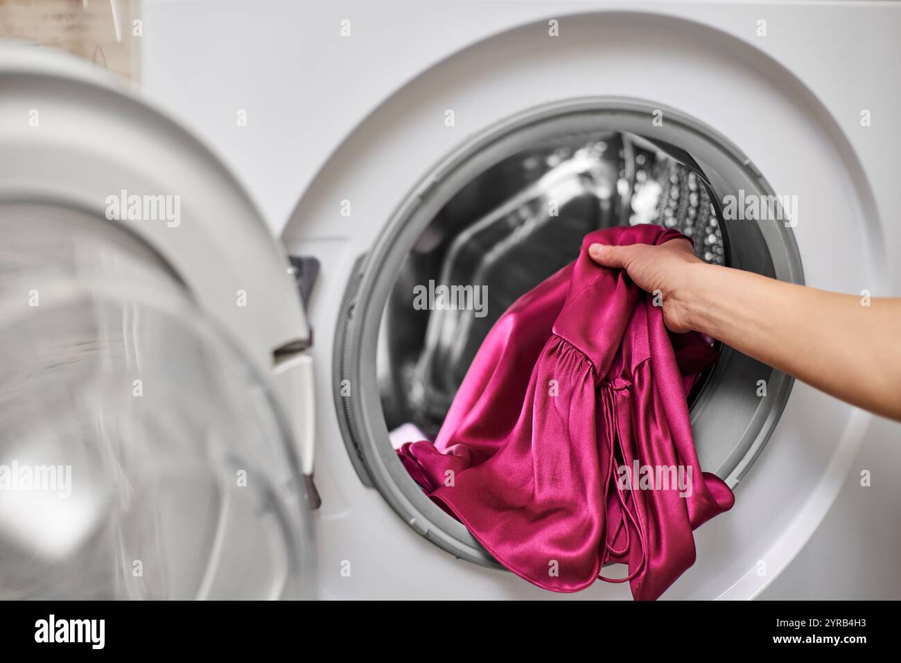 Woman putting washing machine hi-res stock photography and images - Alamy