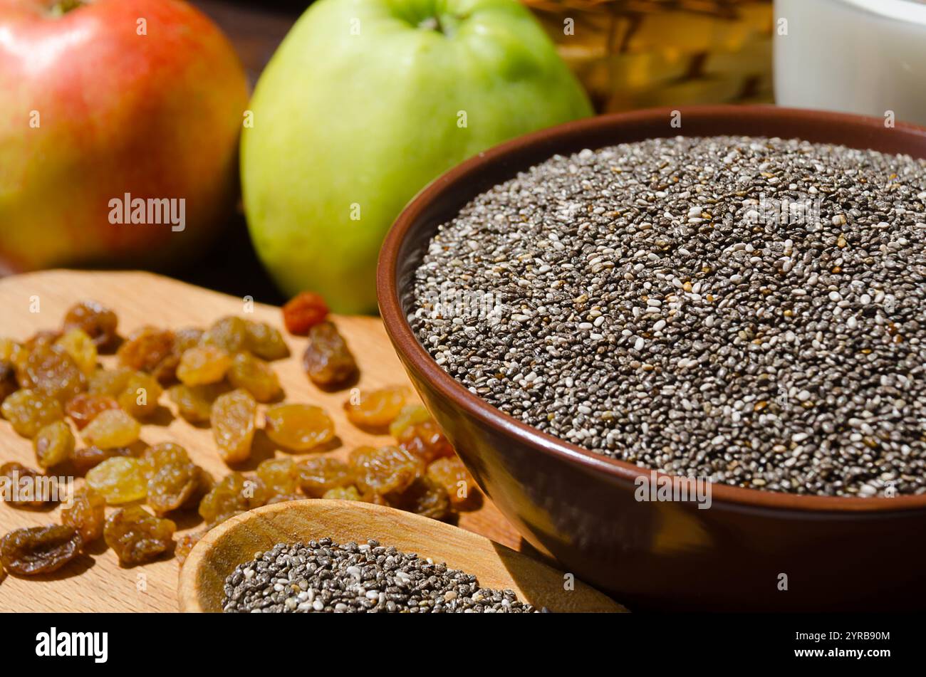 Chia in a bowl, raisins and yogurt. Chia is a plant of the Lamiaceae ...