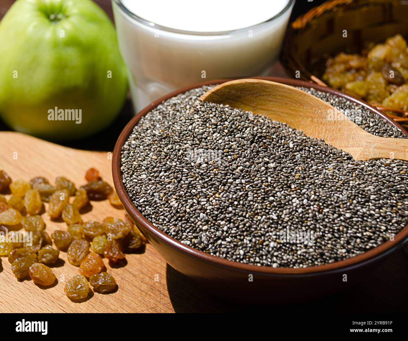 Chia in a bowl, raisins and yogurt. Chia is a plant of the Lamiaceae ...