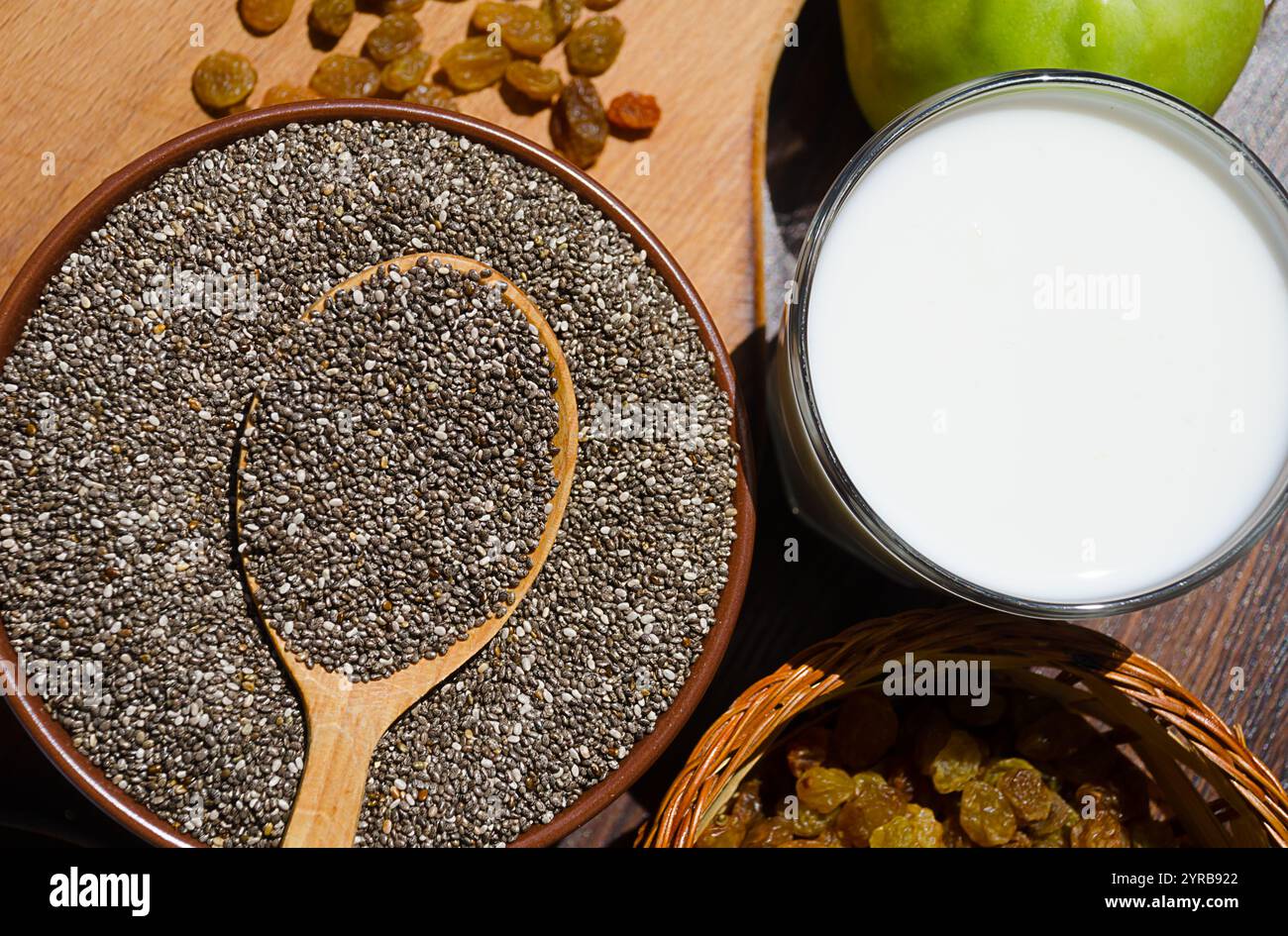 Chia in a bowl, raisins and yogurt. Chia is a plant of the Lamiaceae ...