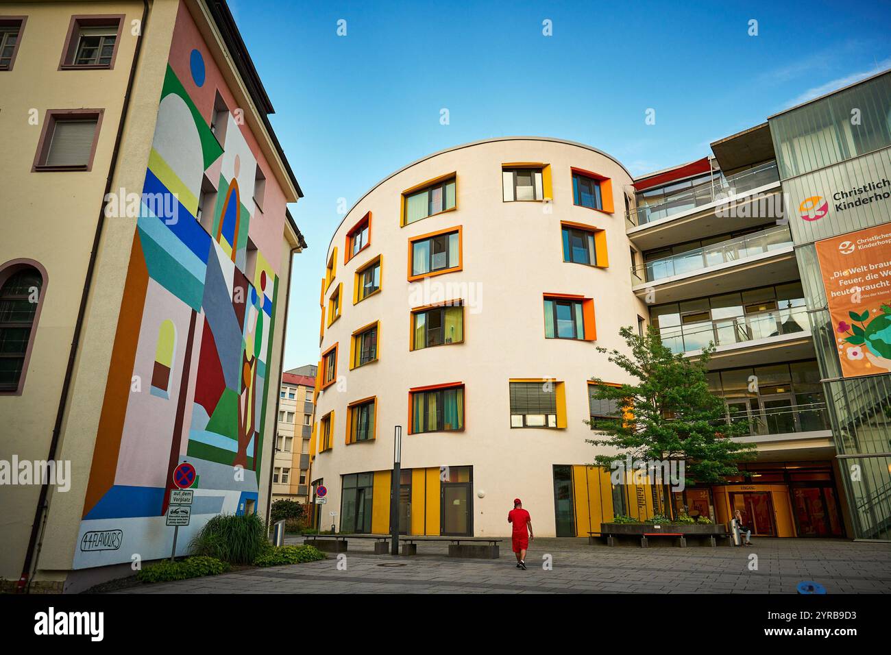 A vibrant scene in Osnabruck, Germany, featuring two distinct buildings ...