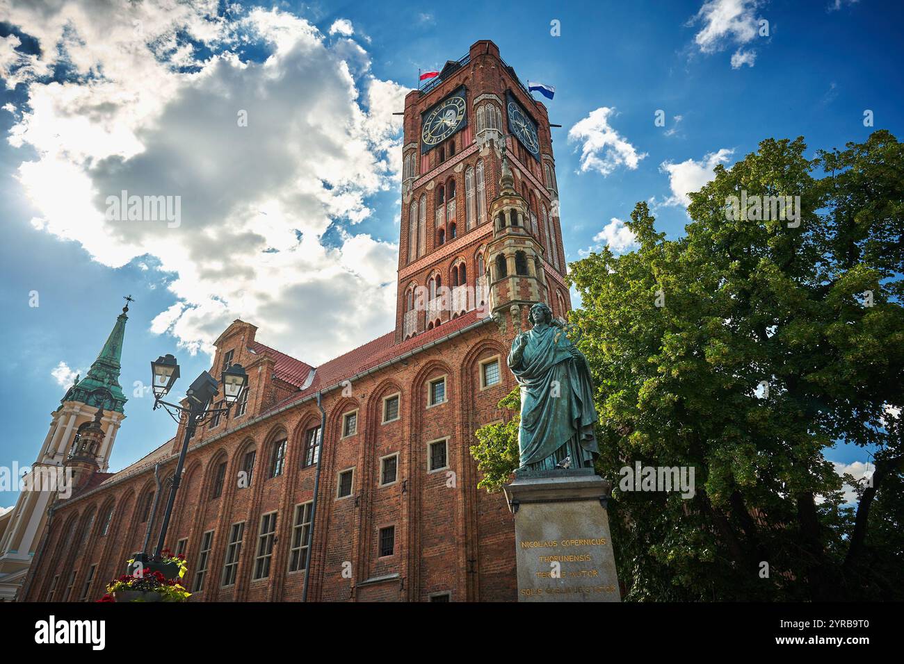 A striking view of the Clock Tower in Torun and a statue of Nicolaus ...