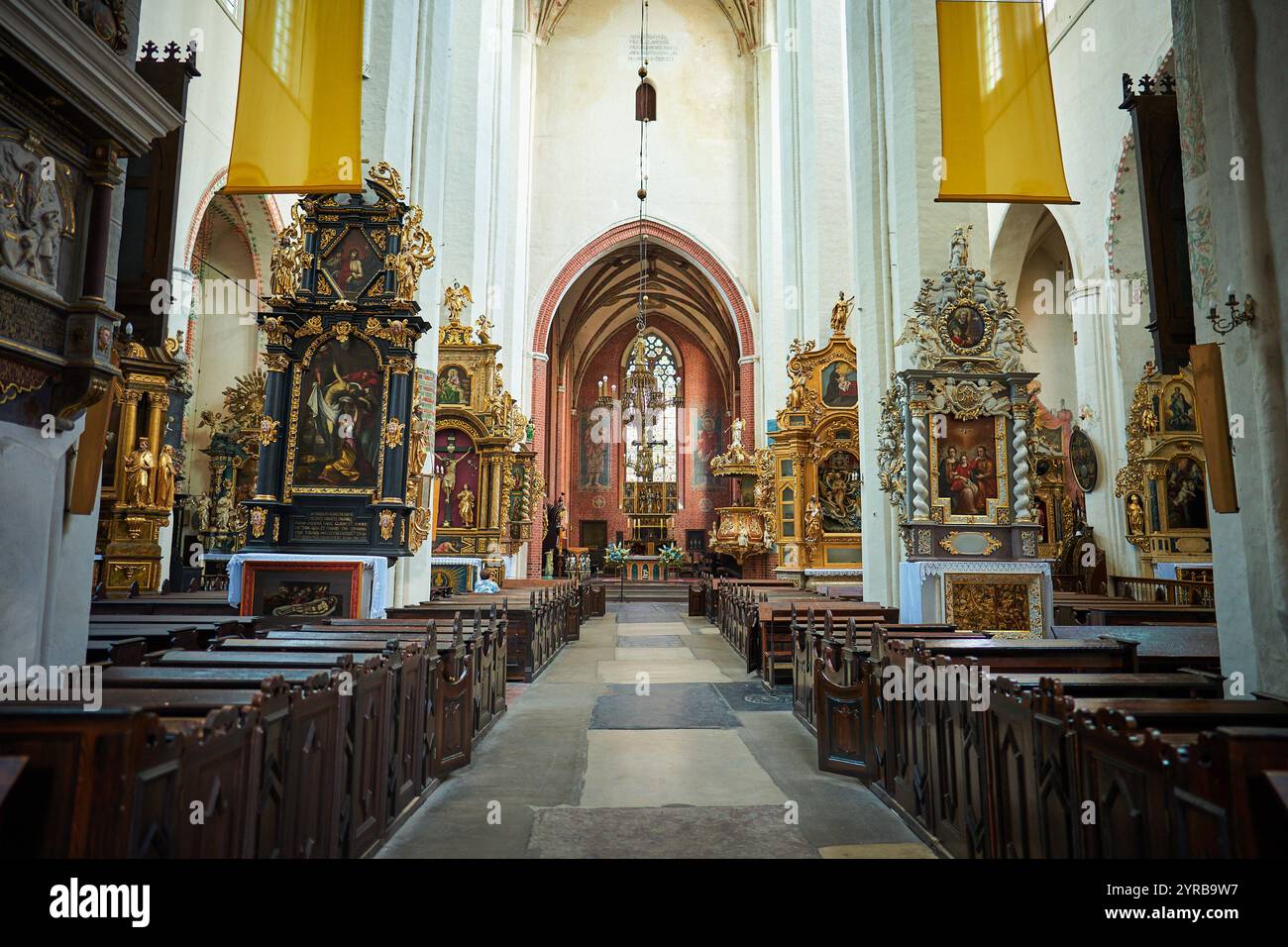 Interior of a historic church in Torun featuring ornate altars and ...