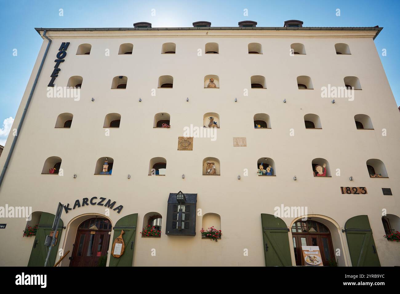 A charming hotel building in Torun featuring playful decorations in its ...