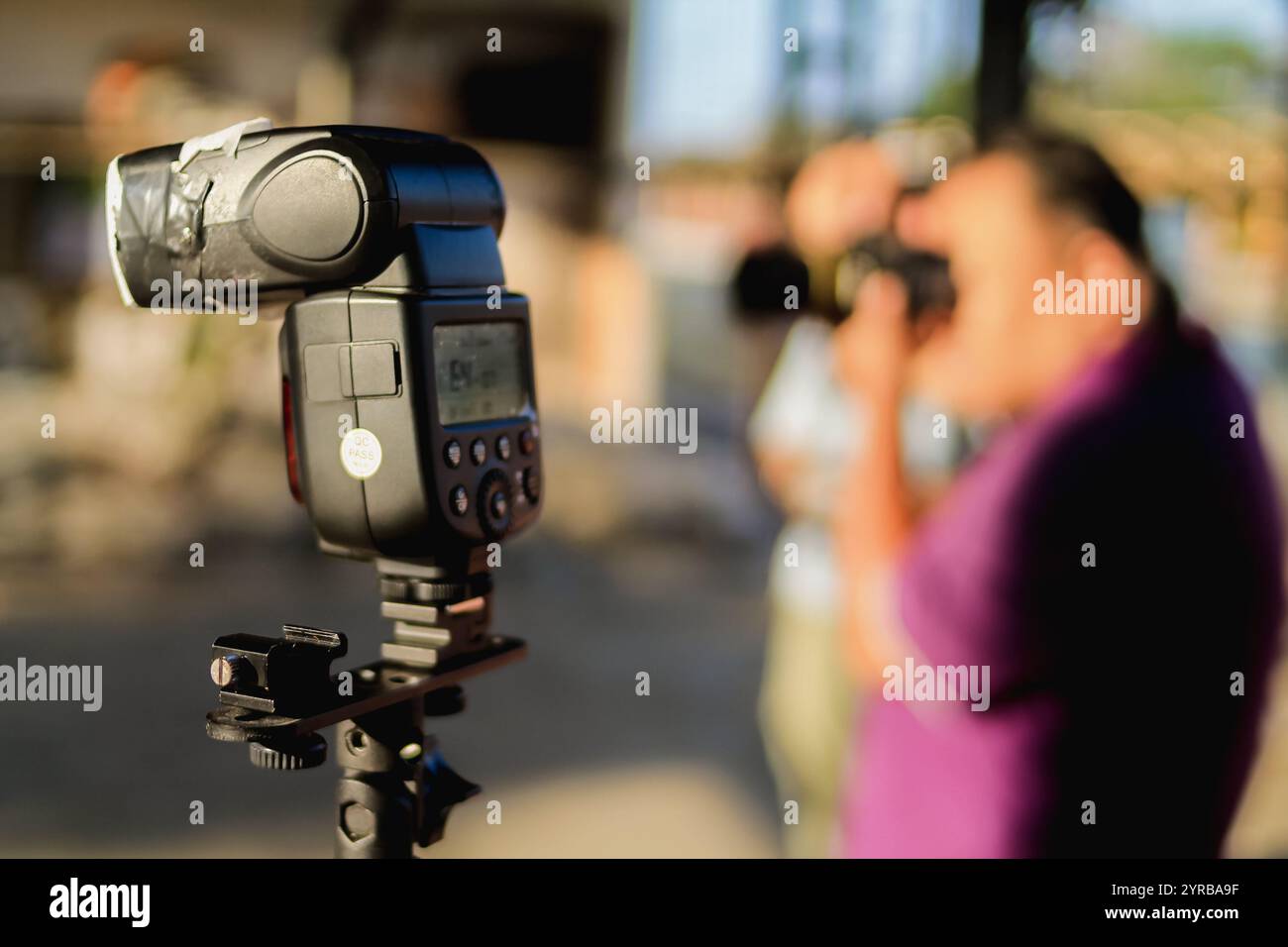 A group of photographers is recording the model using a separate flash ...