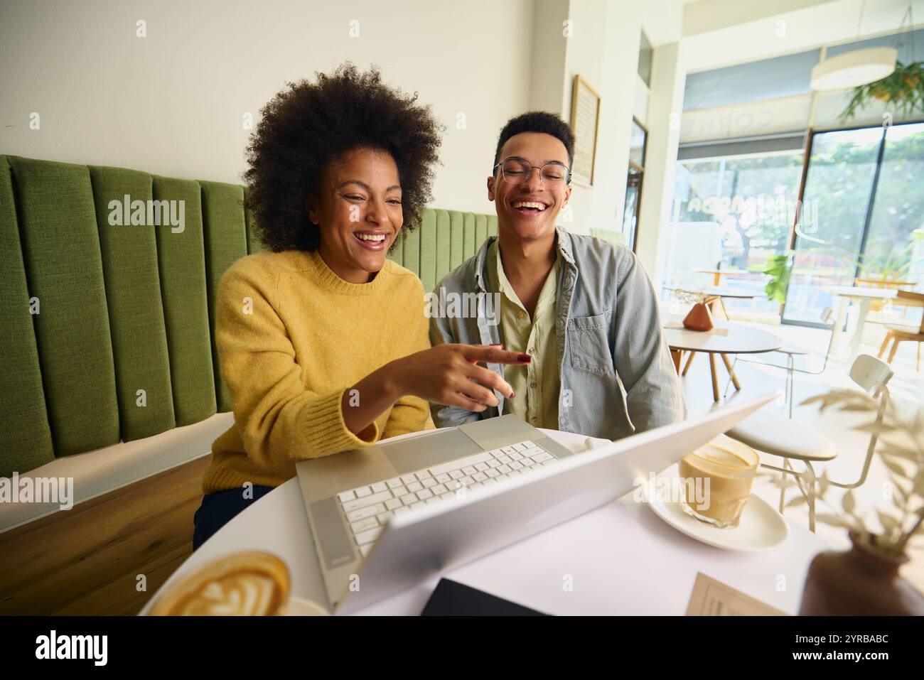 African American people laughing at something funny on the computer ...