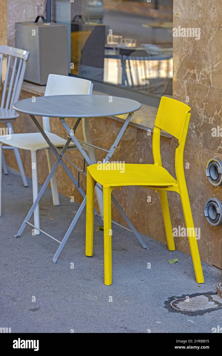 Bright Yellow Chair With Folding Table in Front of Building at Street ...