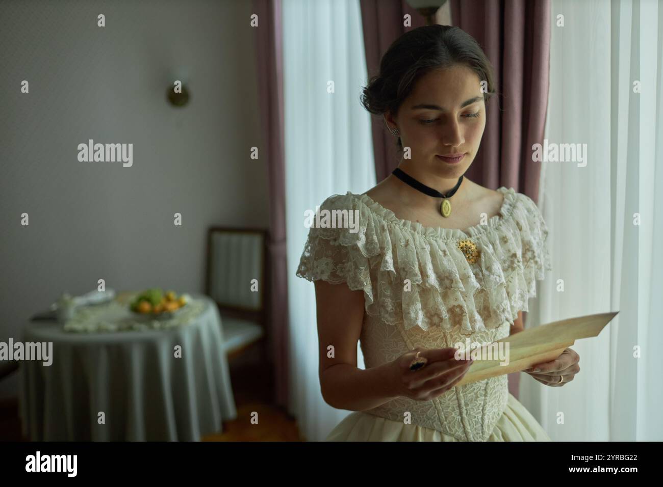 Waist up portrait of romantic young lady reading letter with thoughtful ...