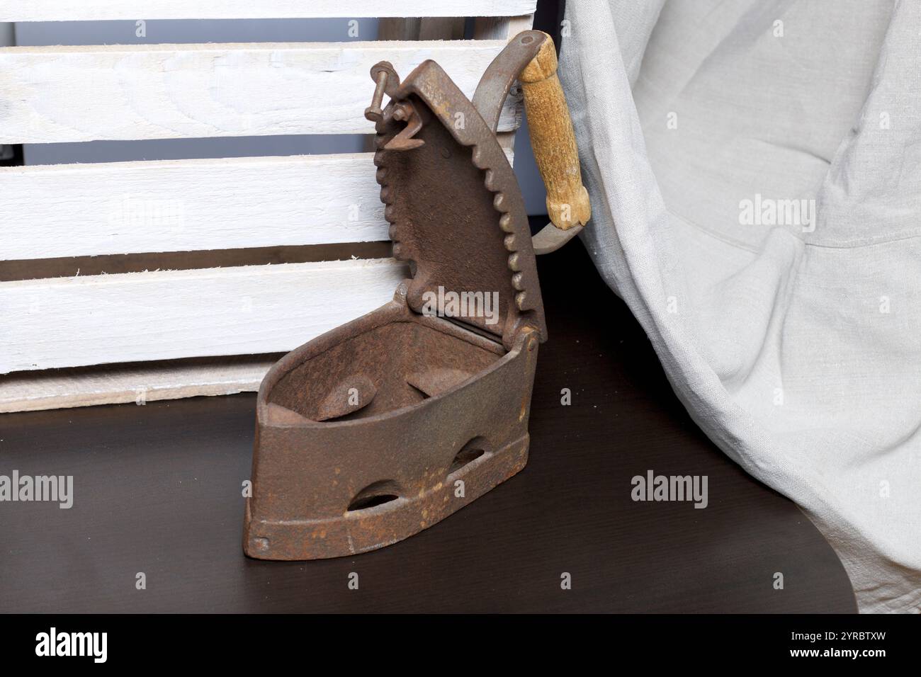 Old iron, heated by hot coals. Opened coal compartment. Standing next ...