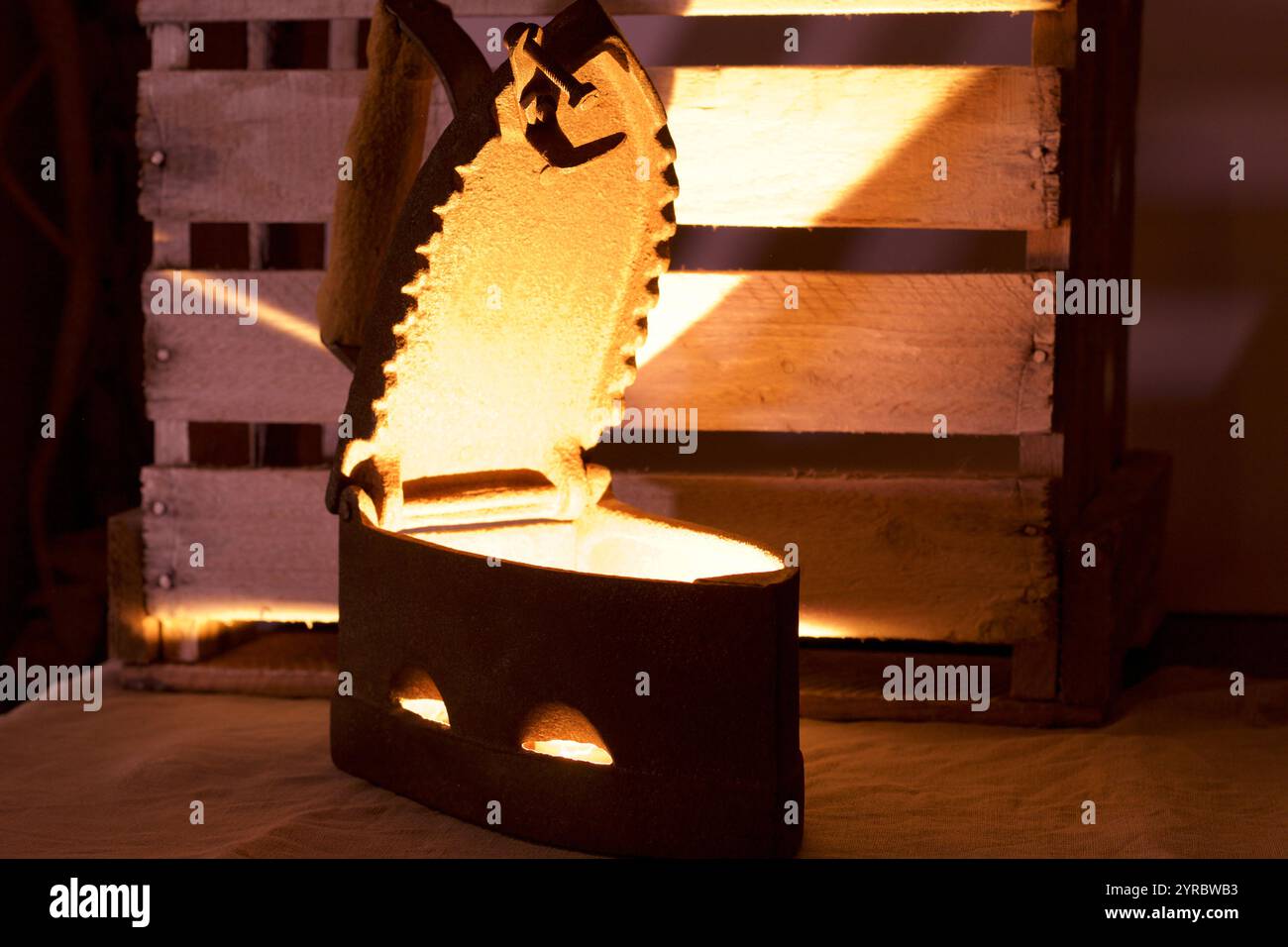 Old iron, heated by hot coals. Opened coal compartment. In the twilight ...