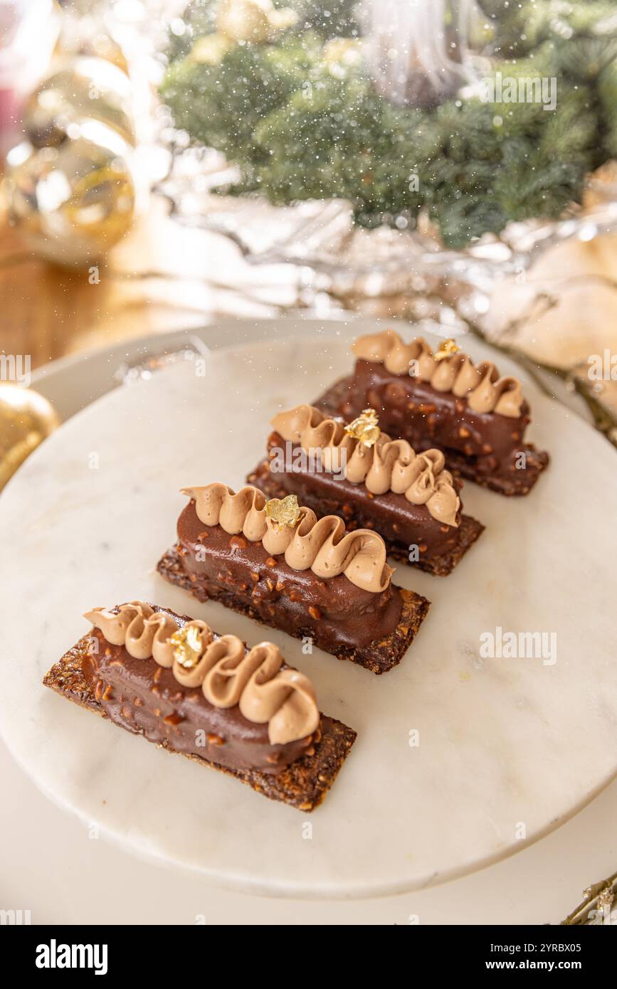 Chocolate hazelnut cakes with gold flakes sprinkled with icing sugar ...