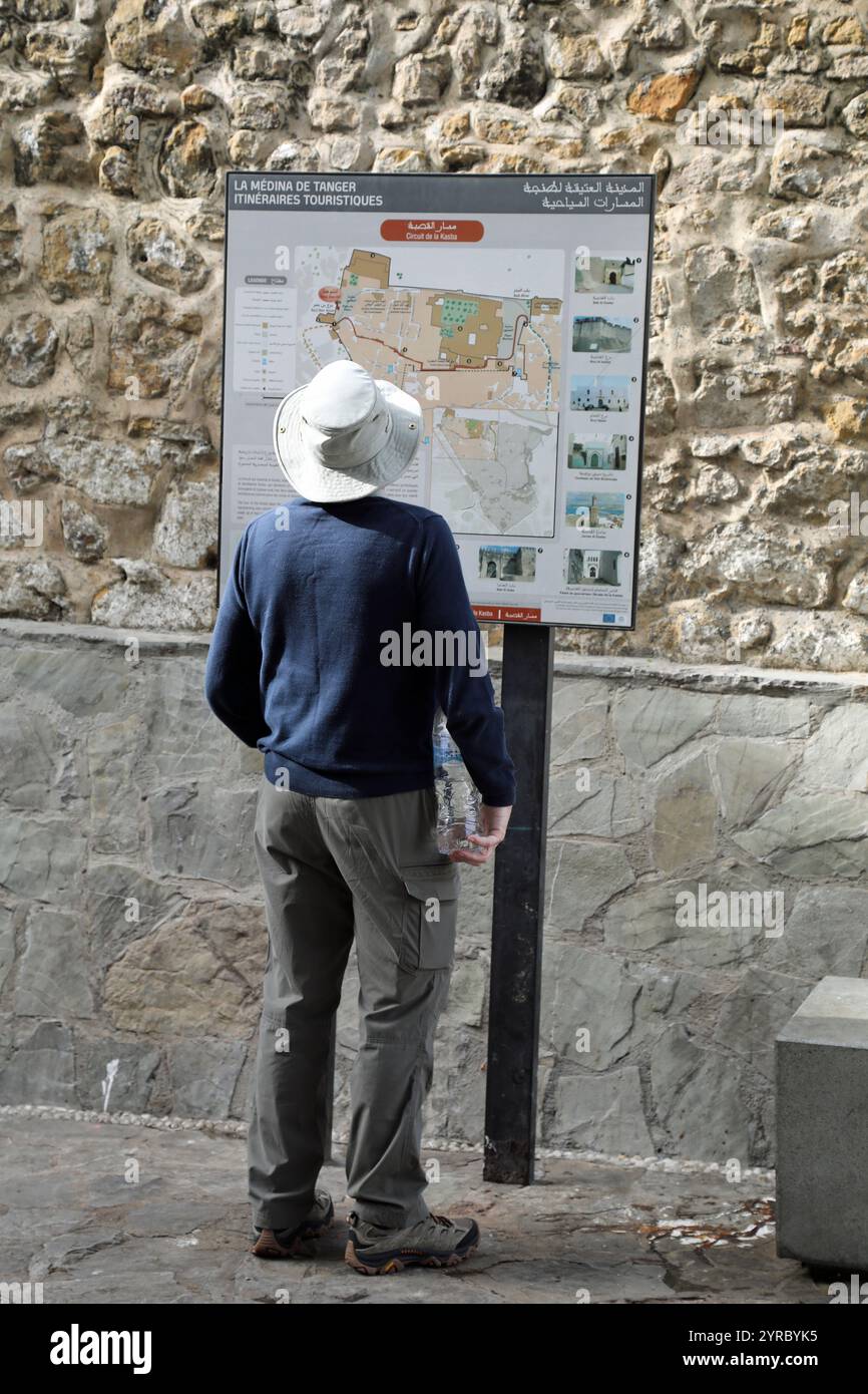 Tourist looking at a map in the Medina of Tangier Stock Photo - Alamy