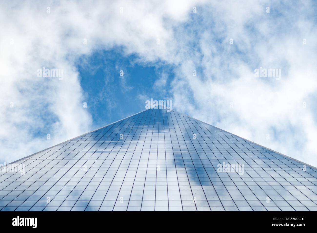 The summit of One World Trade Center pierces through a canvas of clouds ...
