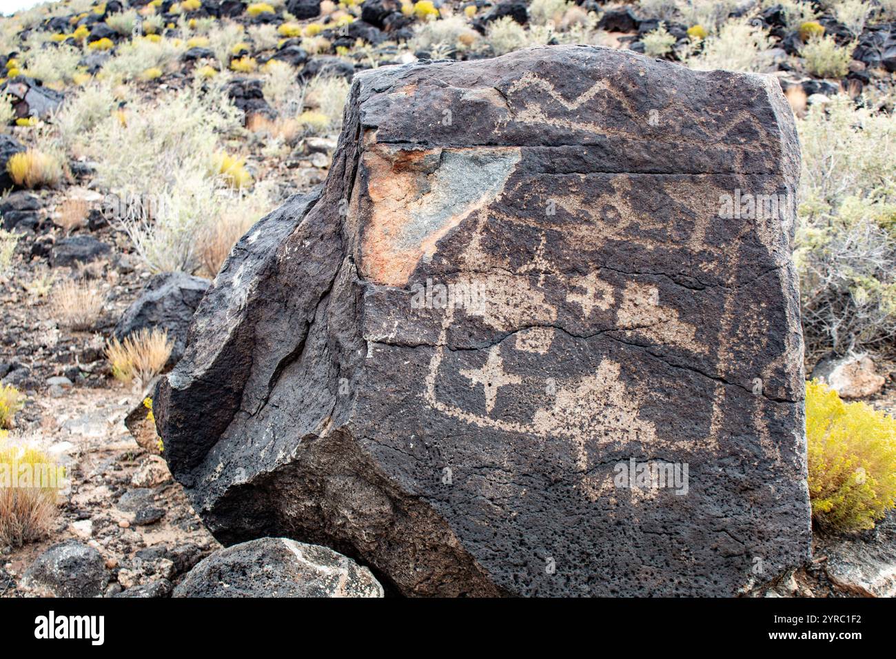 Ancient petroglyphs carved into volcanic rock at Petroglyph Monument ...