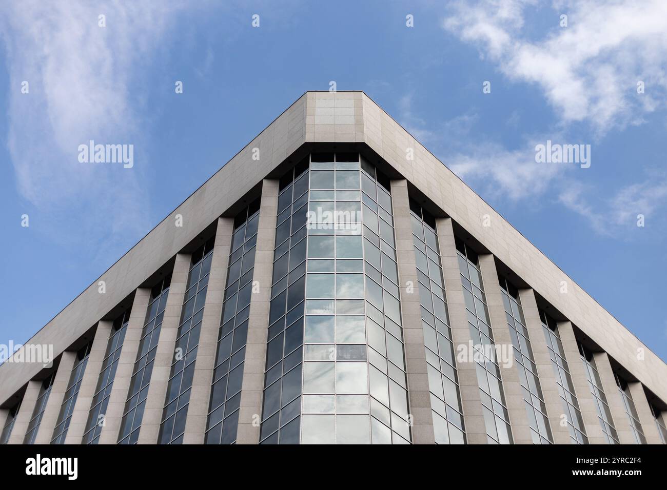 A Modern Ottawa Building Featuring Angular Glass Windows And A Concrete Facade Blending