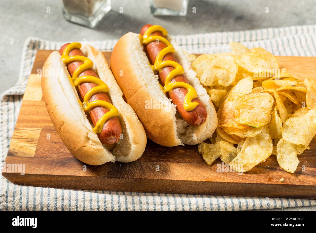 Homemade Boiled Hot Dogs with Mustard and Chips Stock Photo - Alamy