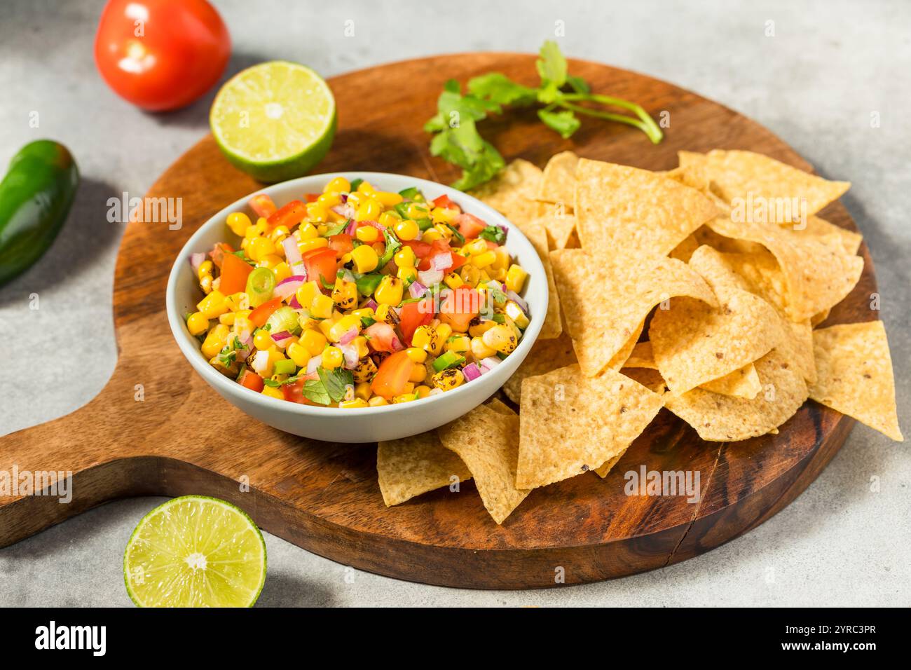 Homemade Spicy Corn Salsa with Tortilla Chips and Lime Stock Photo - Alamy