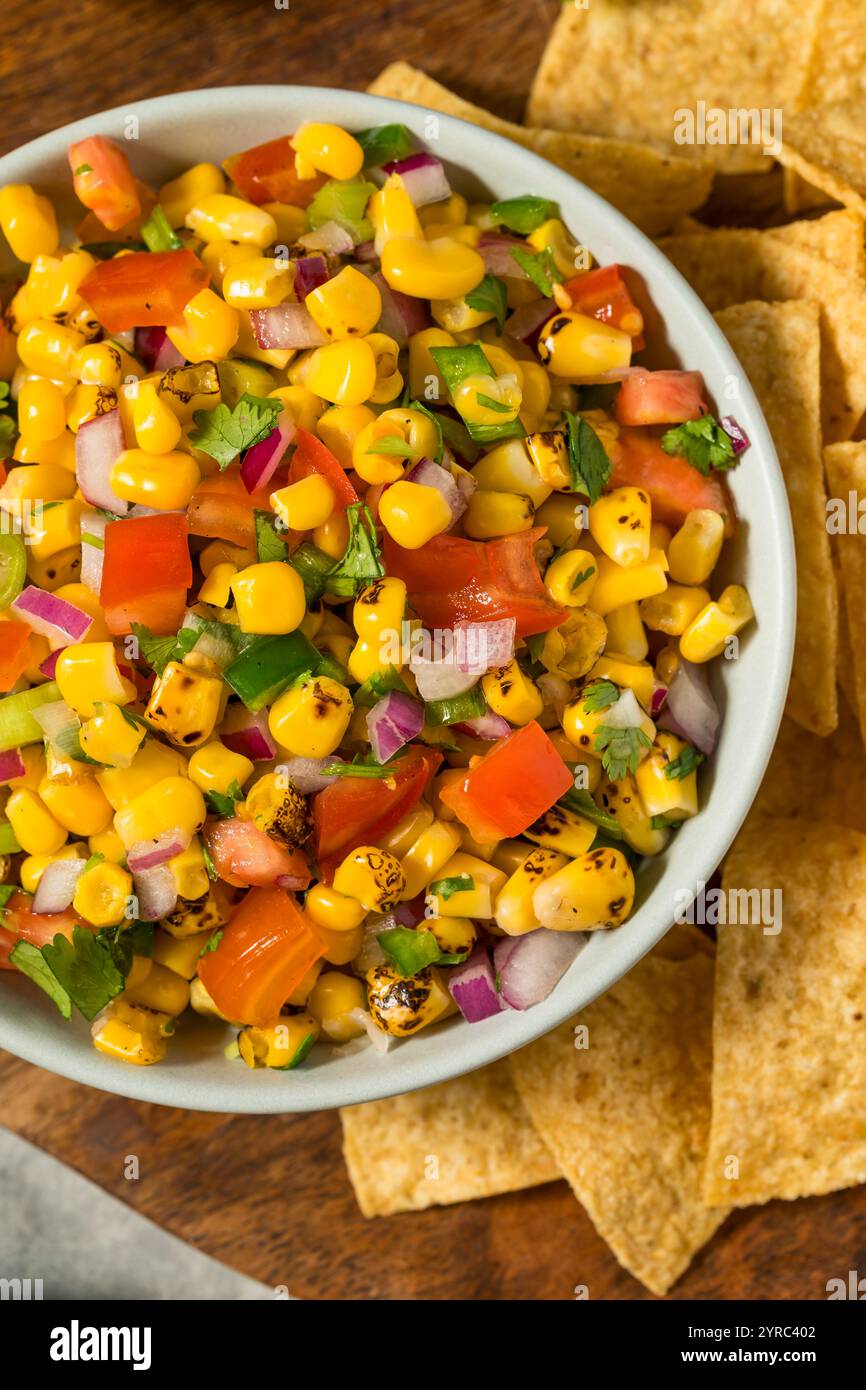 Homemade Spicy Corn Salsa with Tortilla Chips and Lime Stock Photo - Alamy