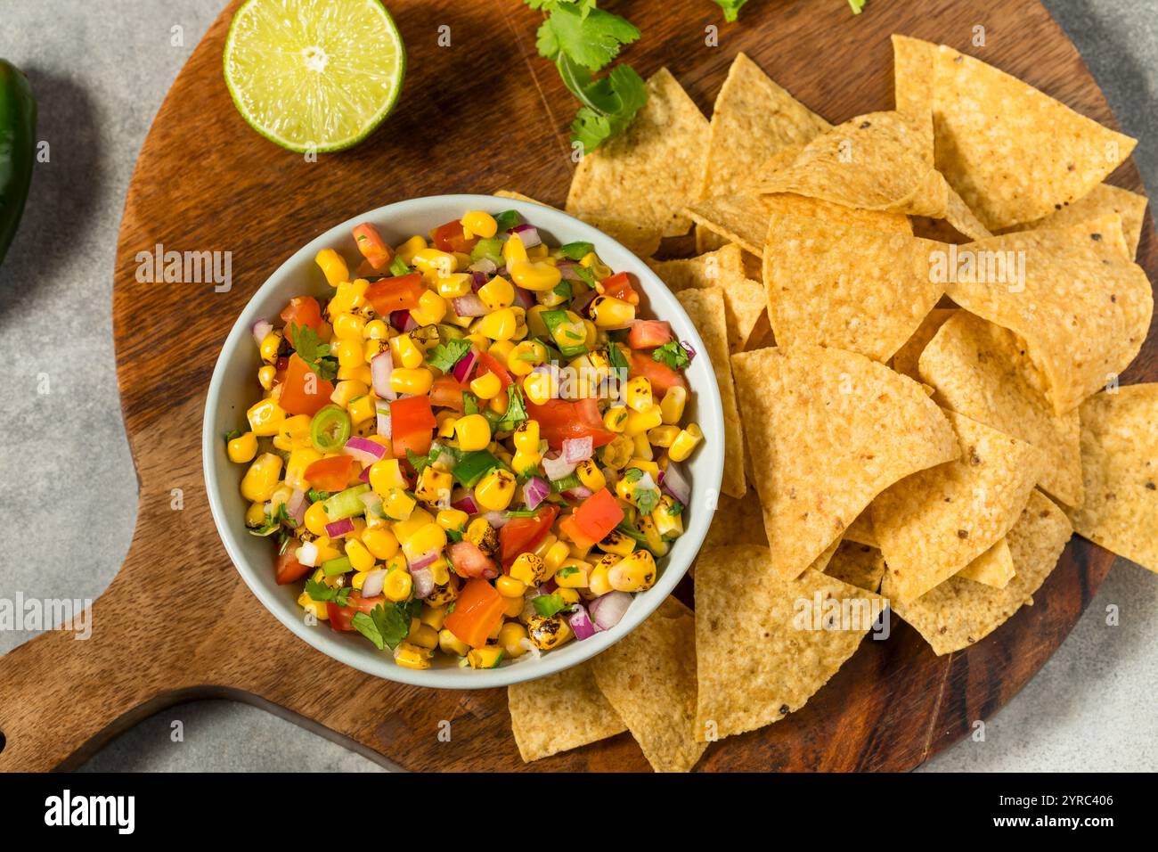 Homemade Spicy Corn Salsa with Tortilla Chips and Lime Stock Photo - Alamy