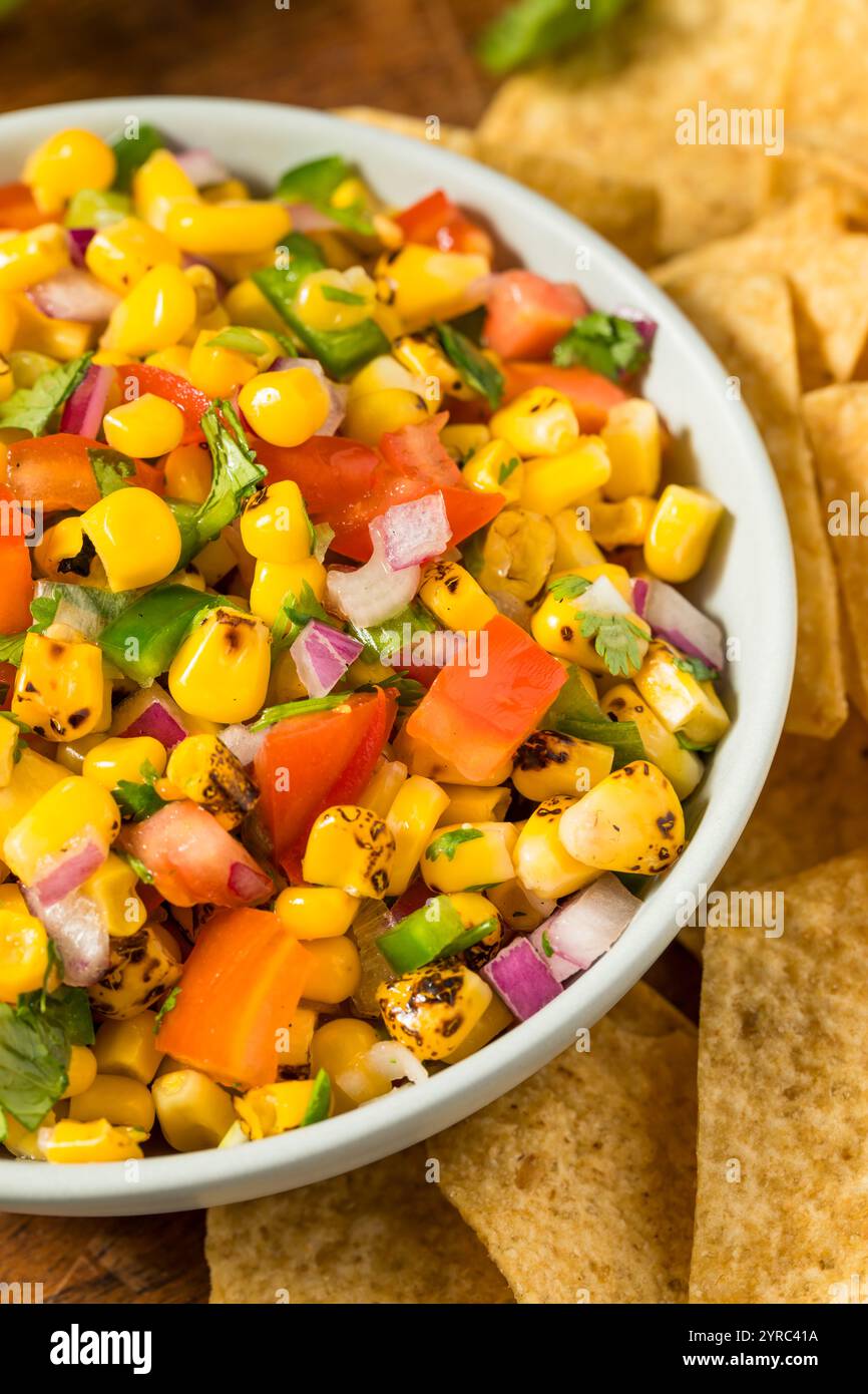 Homemade Spicy Corn Salsa with Tortilla Chips and Lime Stock Photo - Alamy