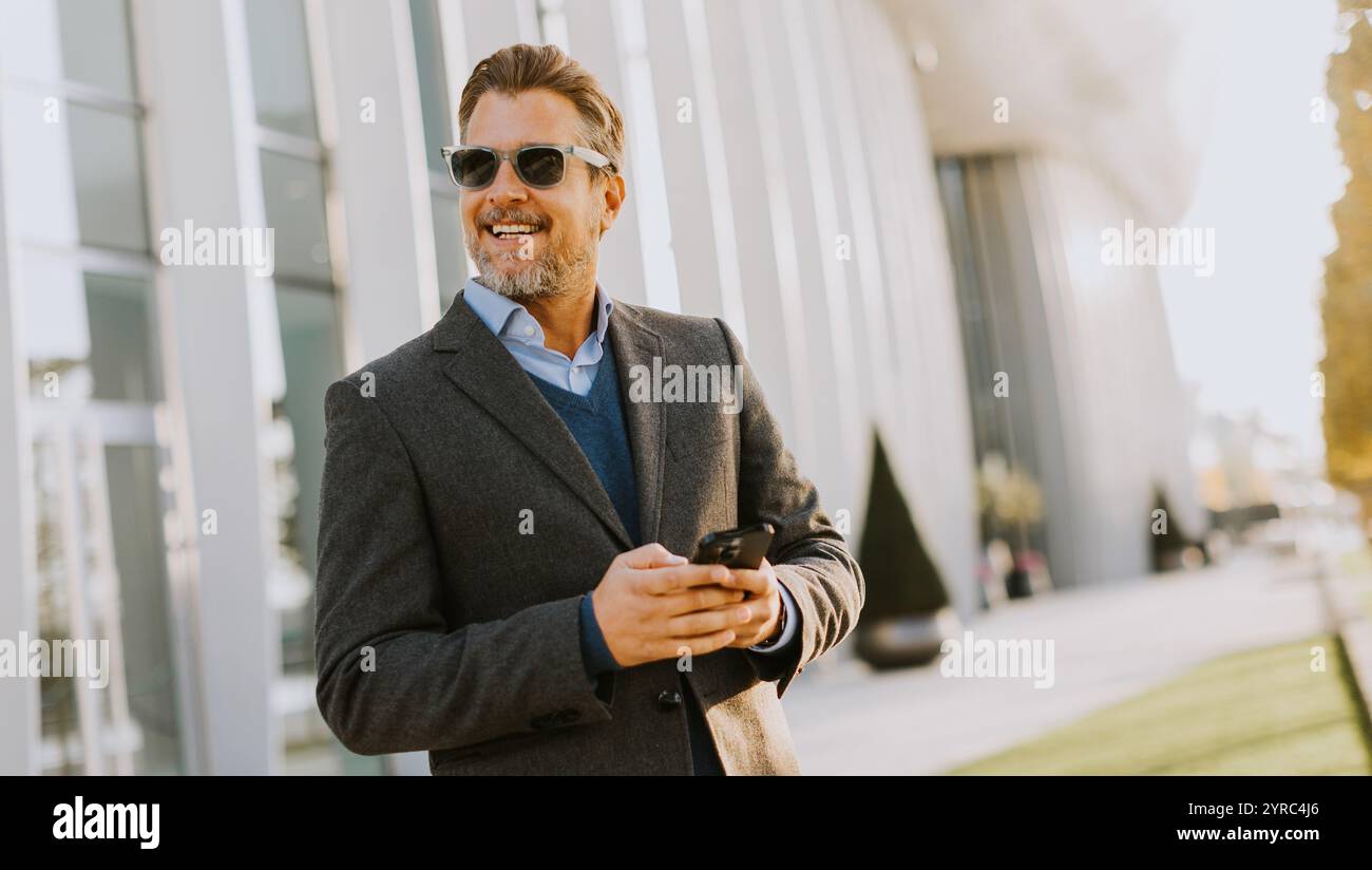 A professional man in stylish attire leisurely walks outside a sleek ...