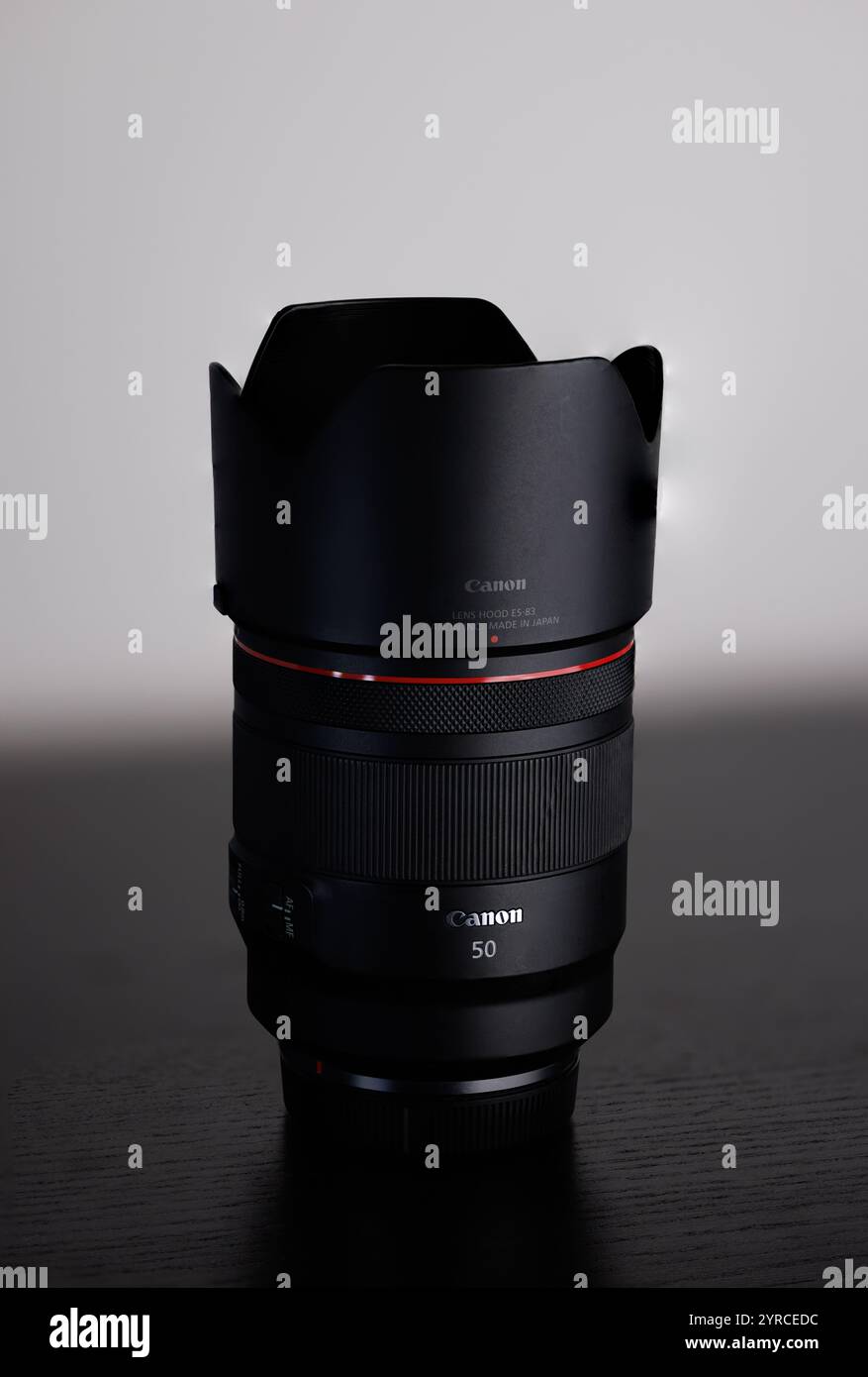 Canon RF 50mm f/1.2L lens with lens hood displayed in a sleek ...