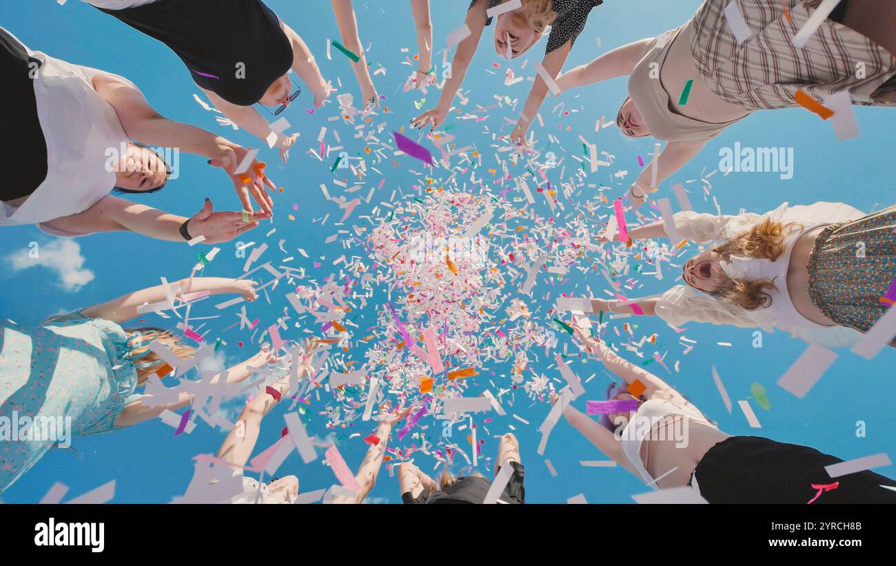 Students toss the confetti up standing in a circle Stock Photo - Alamy
