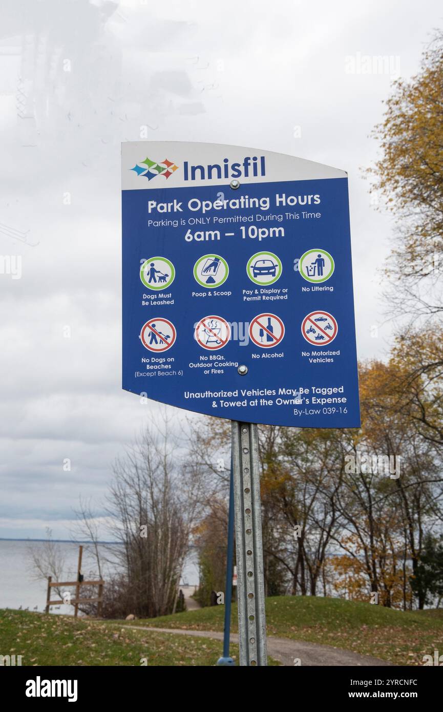 Information sign on operating hours and regulations at Innisfil Beach ...