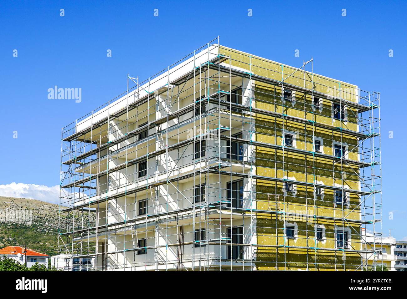 Thermal insulation works of the facade of a apartment building with ...