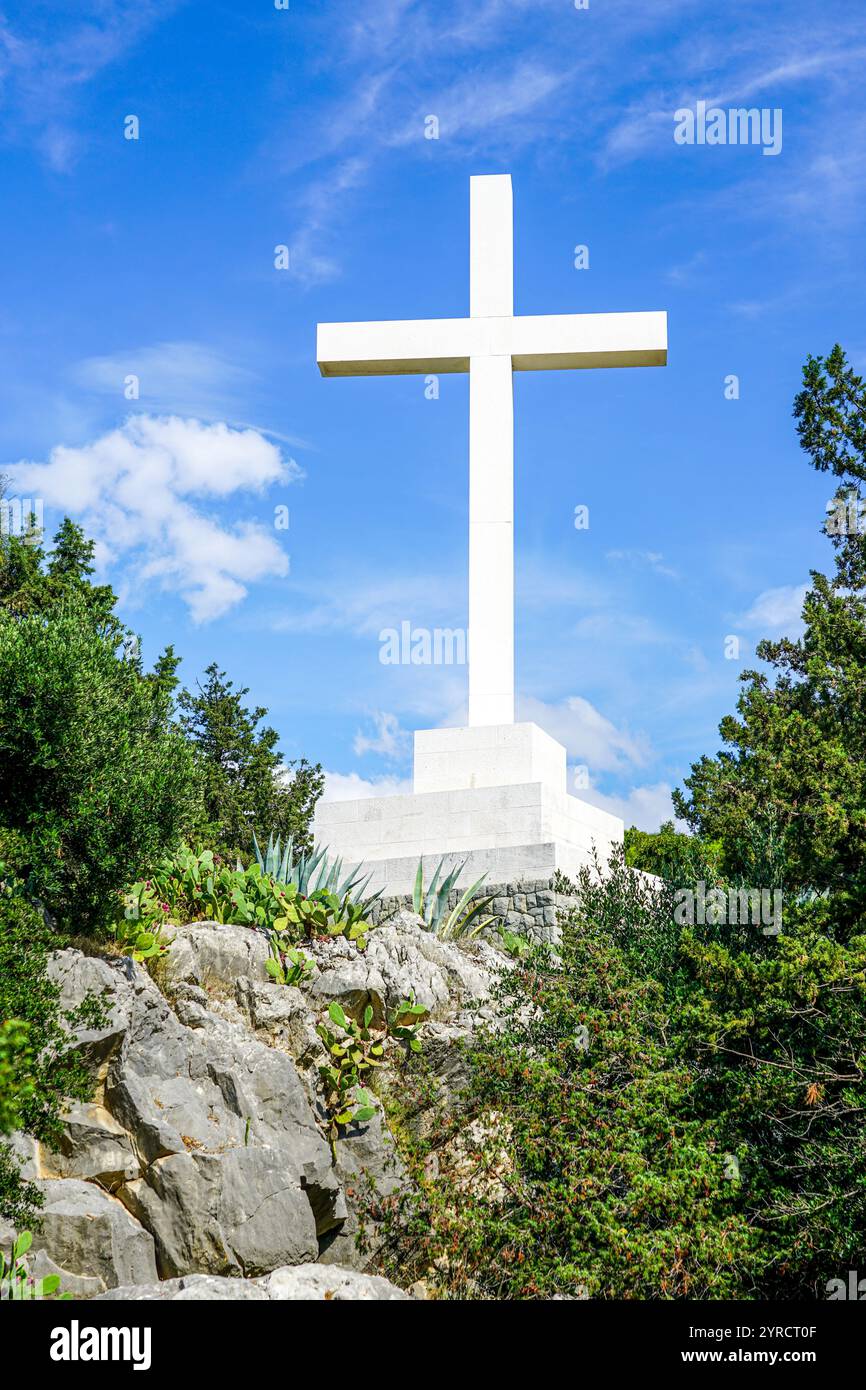 Large white cross monument against a blue sky on the top of Marjan hill ...