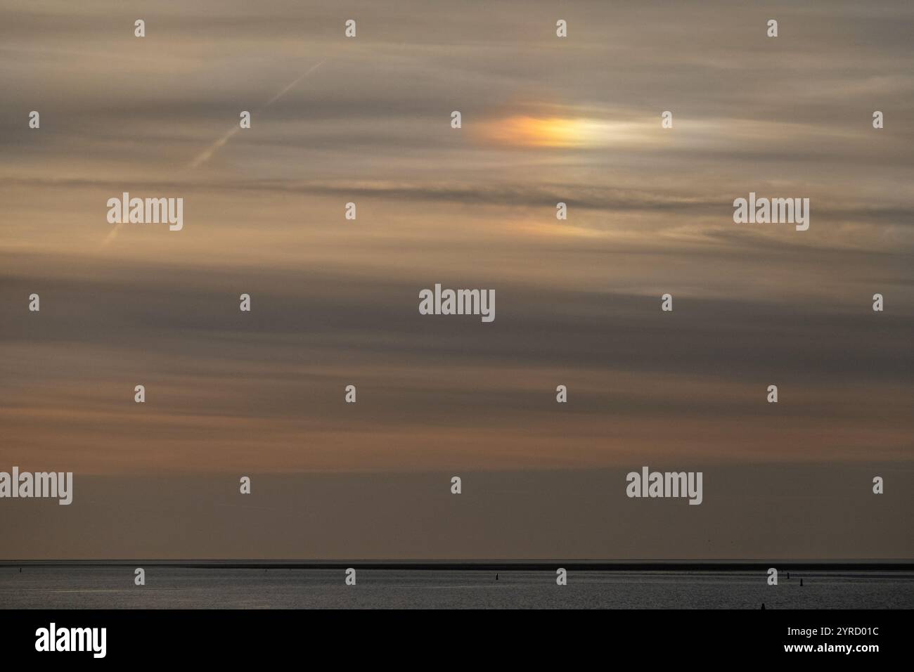 Sundog above sea, caused by refraction of sunlight by ice crystals in ...