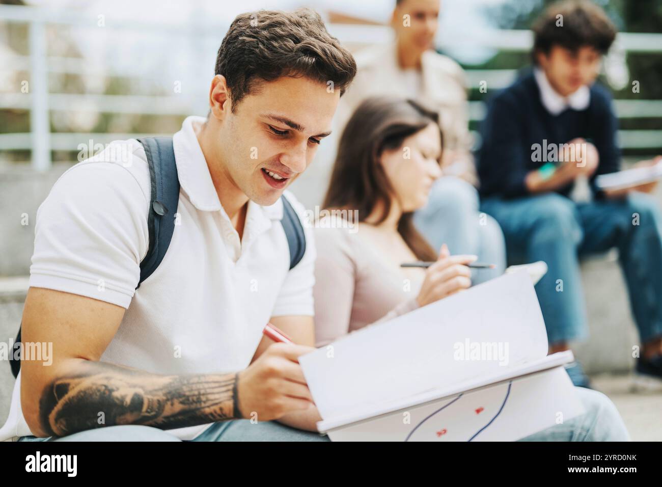 High school students engaged in outdoor learning activities with ...