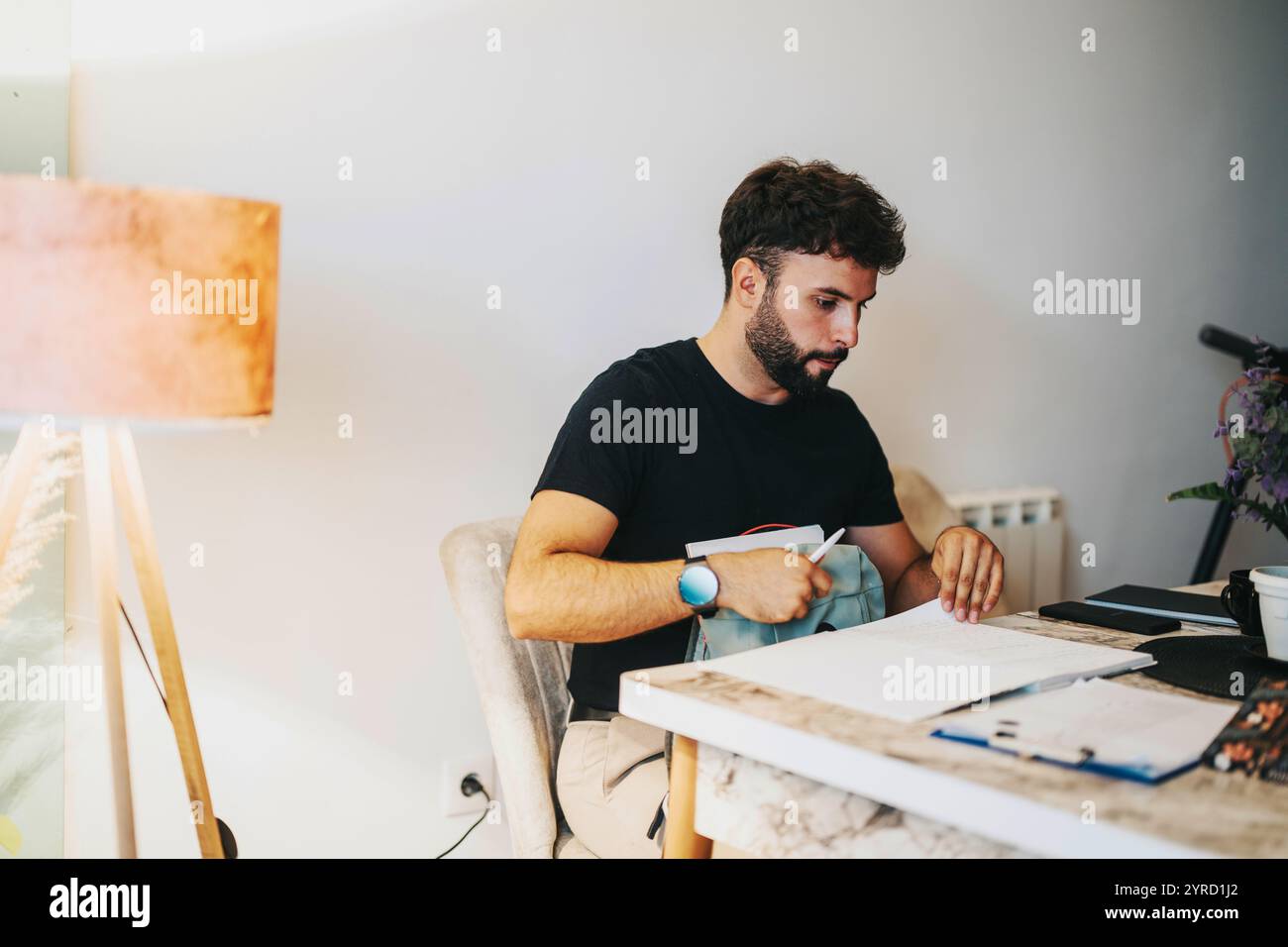 Focused college student studying at home with determination Stock Photo ...