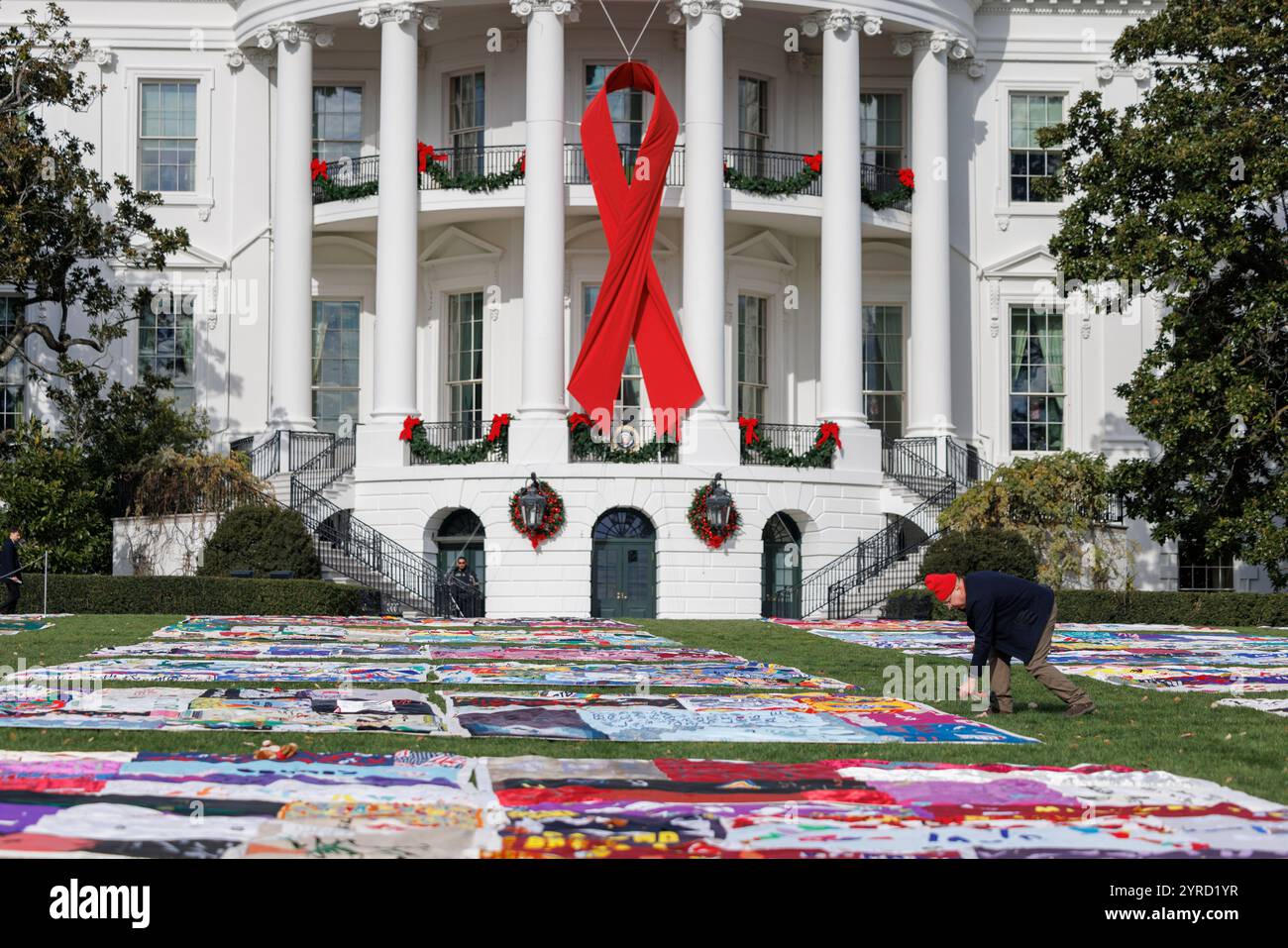 Crews work on the AIDS Memorial Quilt during an event to commemorate ...