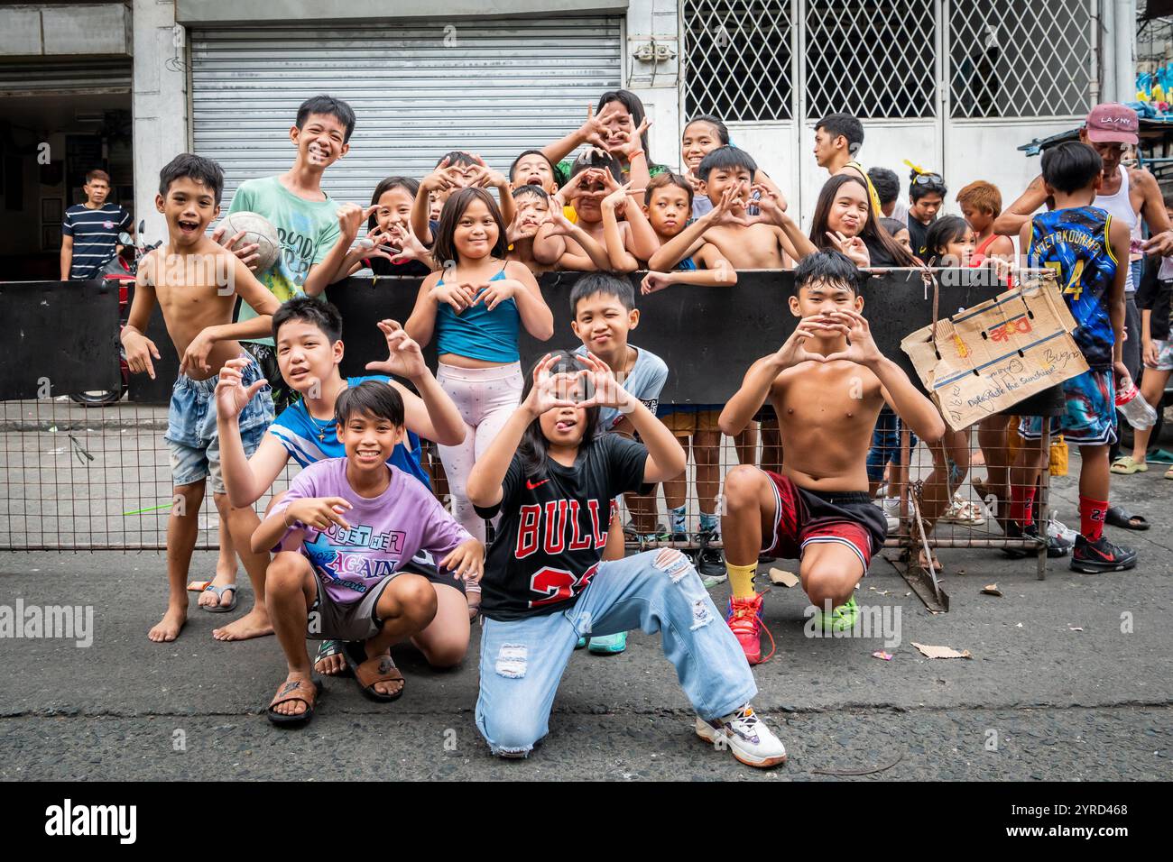 Crowds of cute Filipino children all happily pose and smile for the camera in The Tondo District ...