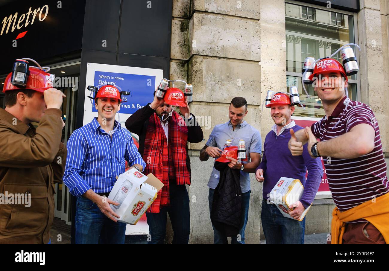 LONDON, UK - MAY 3, 2014: Unidentified men wear "Beer Hands Free Kit ...