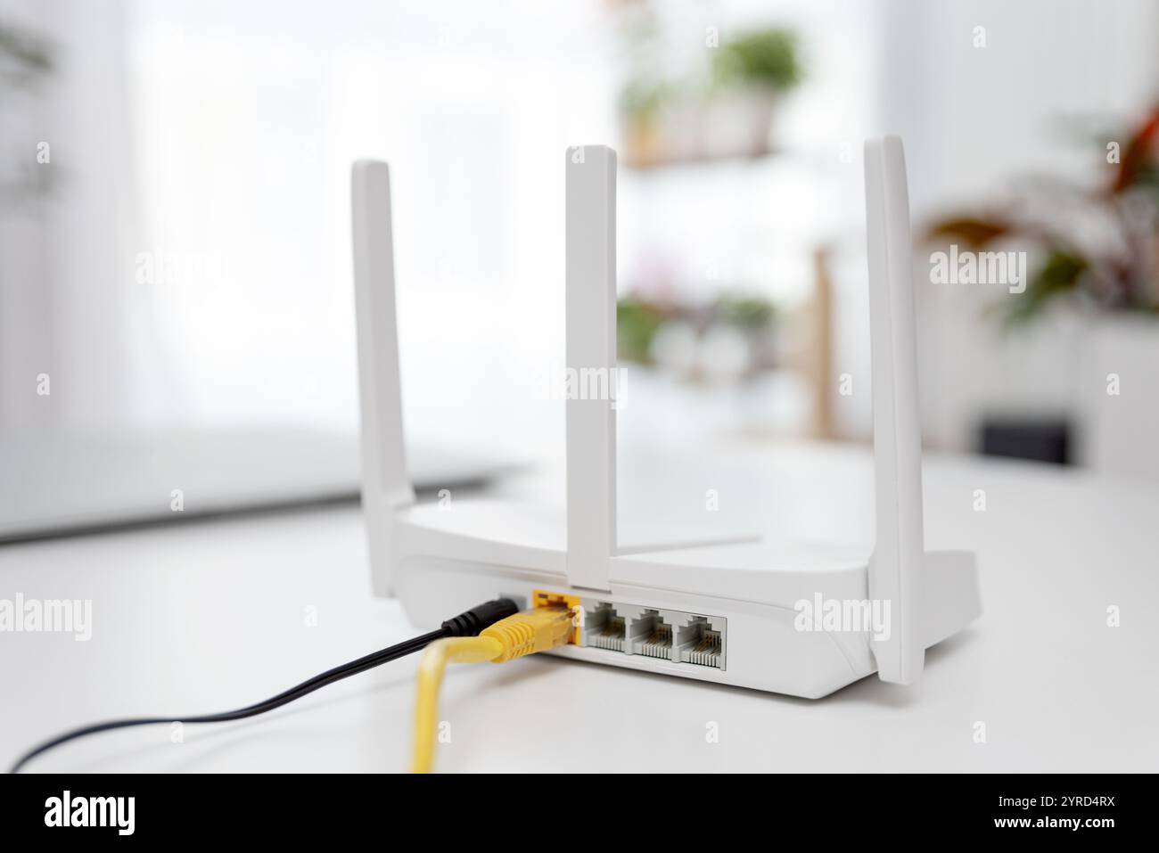 Modern wi-fi router on light table in living room Stock Photo - Alamy