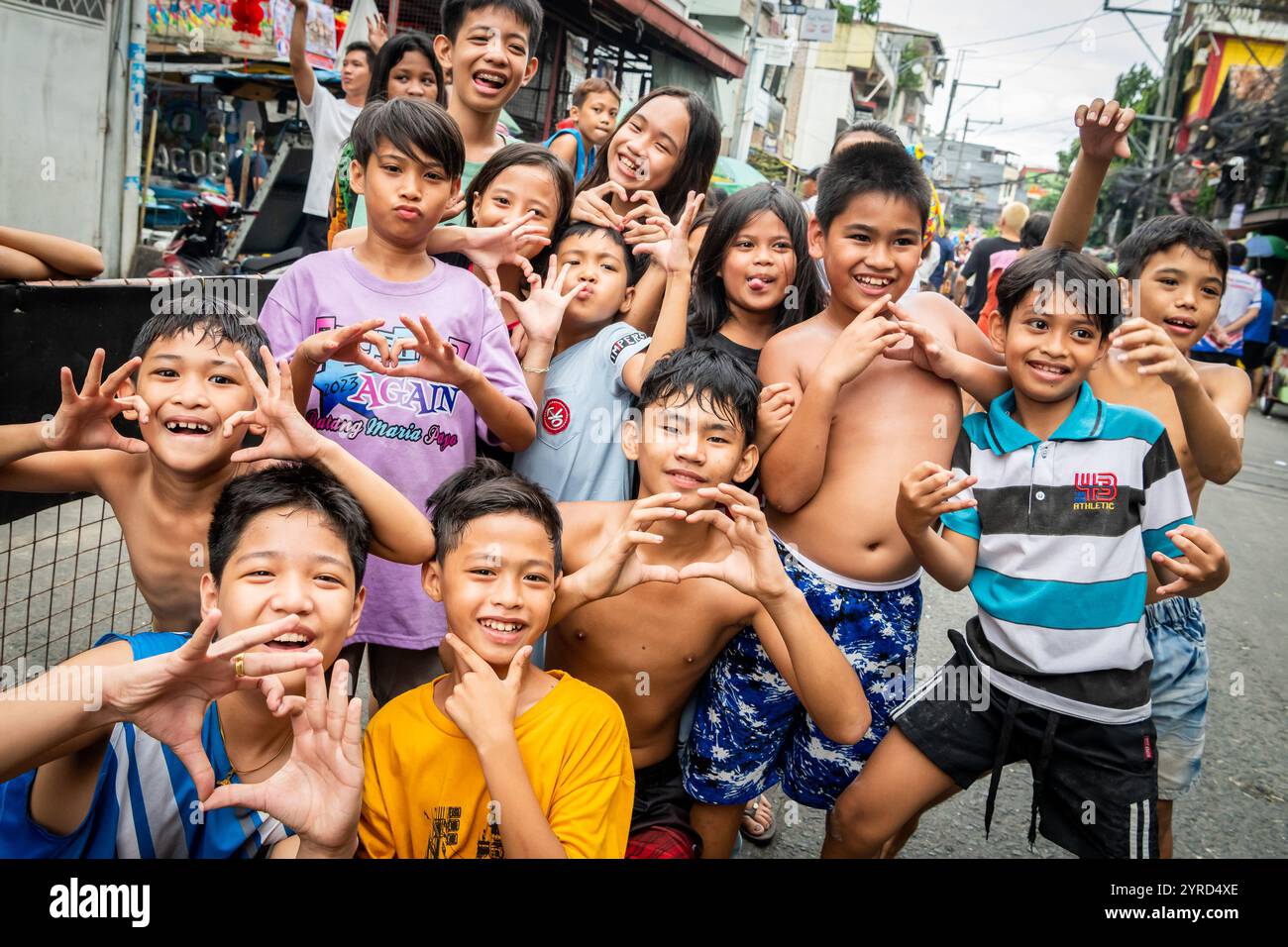 Crowds of cute Filipino children all happily pose and smile for the camera in The Tondo District ...