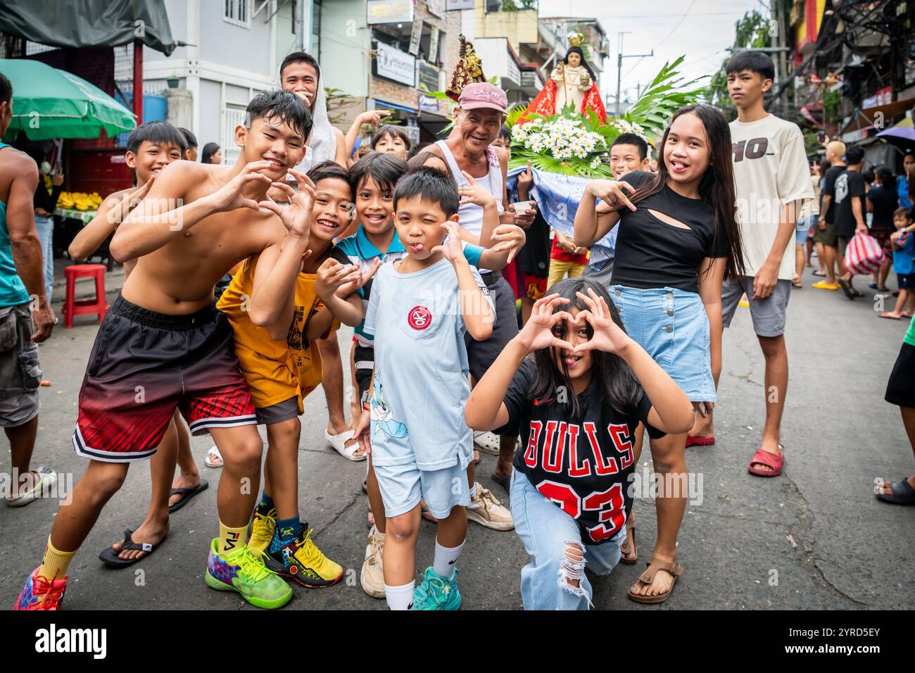 Crowds of cute Filipino children all happily pose and smile for the camera in The Tondo District ...