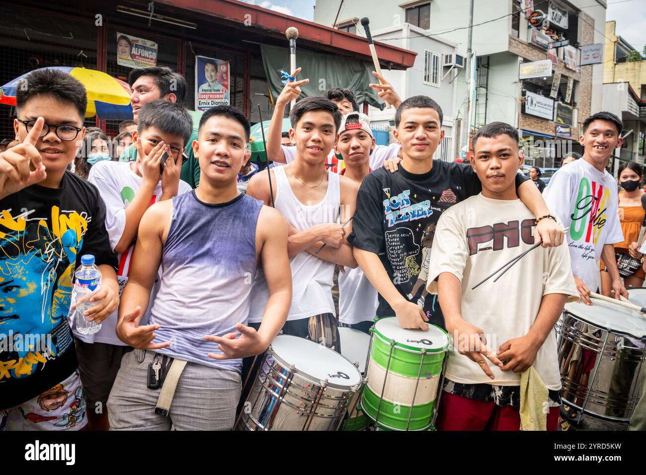 A group of drummers from the street festival happily pose and smile for ...