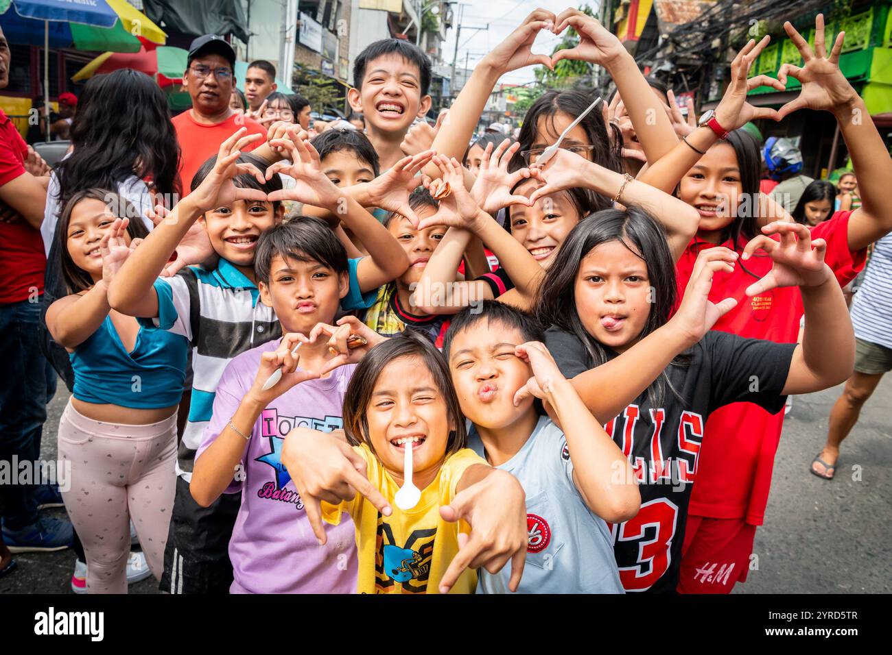 Crowds of cute Filipino children all happily pose and smile for the camera in The Tondo District ...