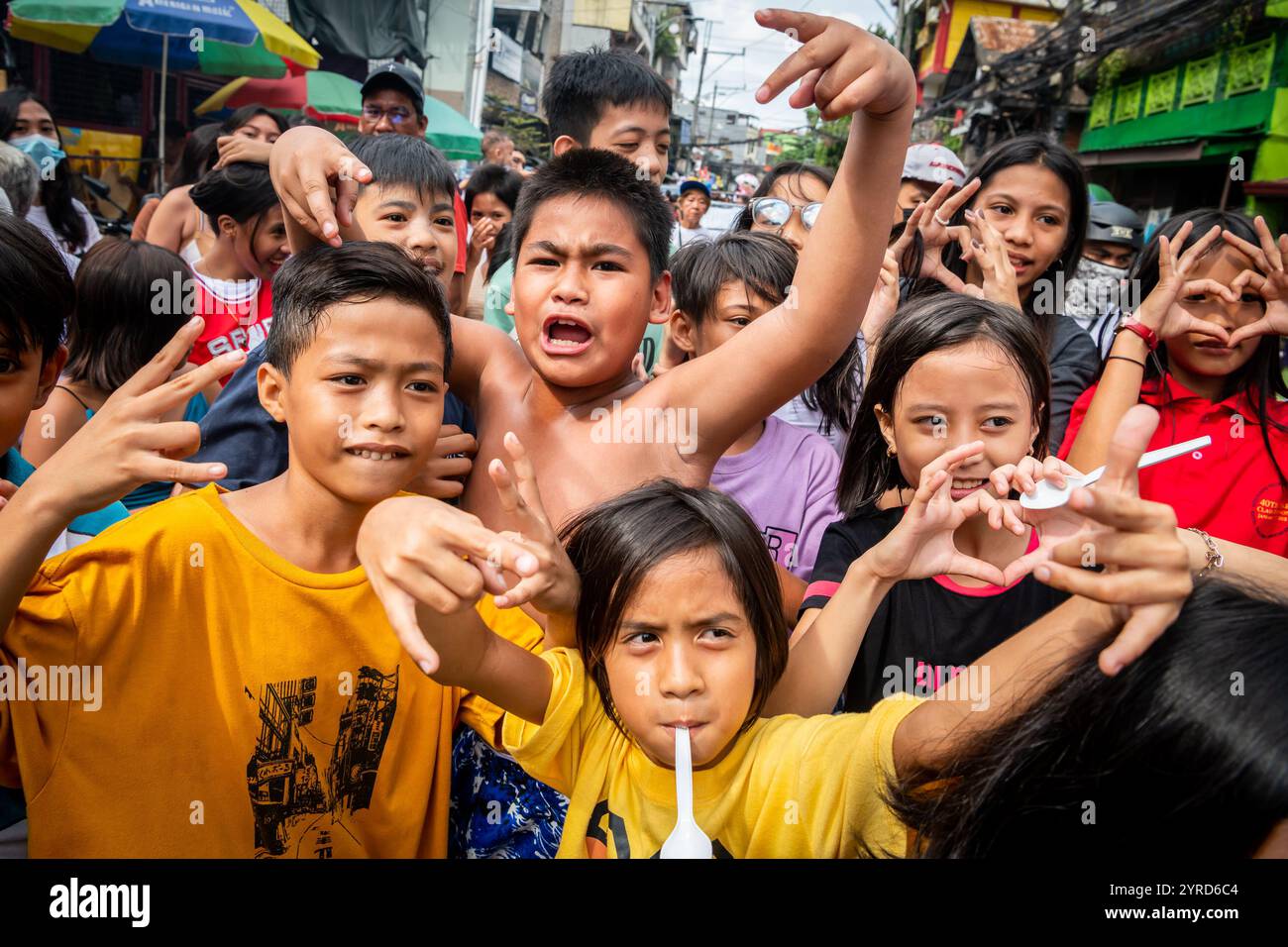 Crowds of cute Filipino children all happily pose and smile for the camera in The Tondo District ...