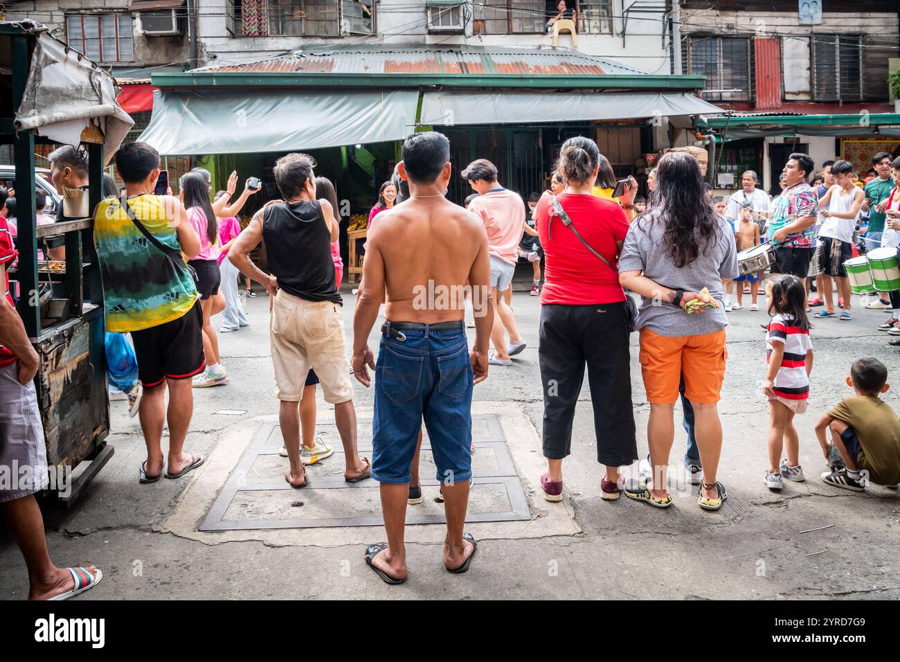 Crowds watch the wonderful religious festival parade make its way through the busy streets of ...