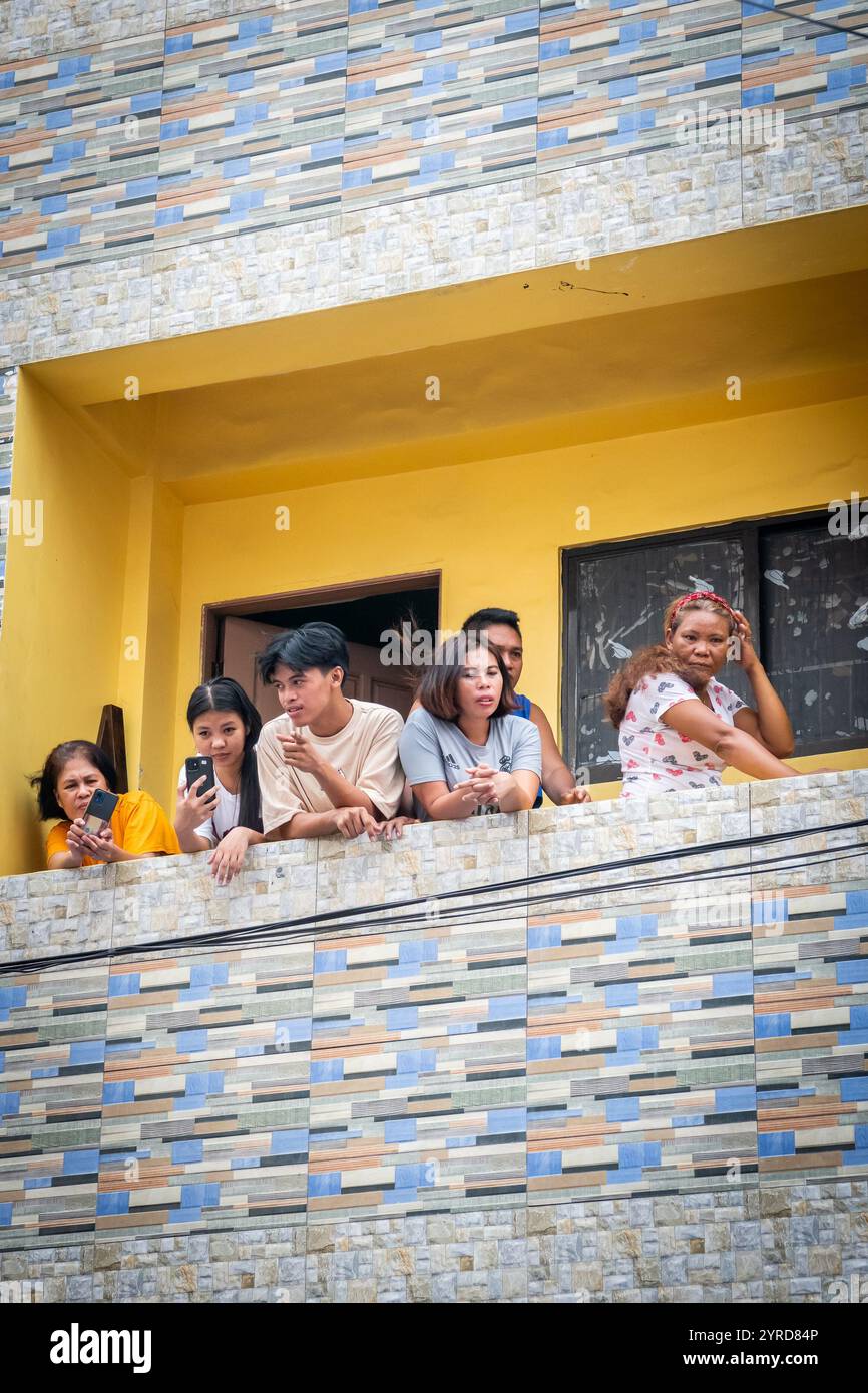 A family watch the wonderful religious festival parade make its way ...