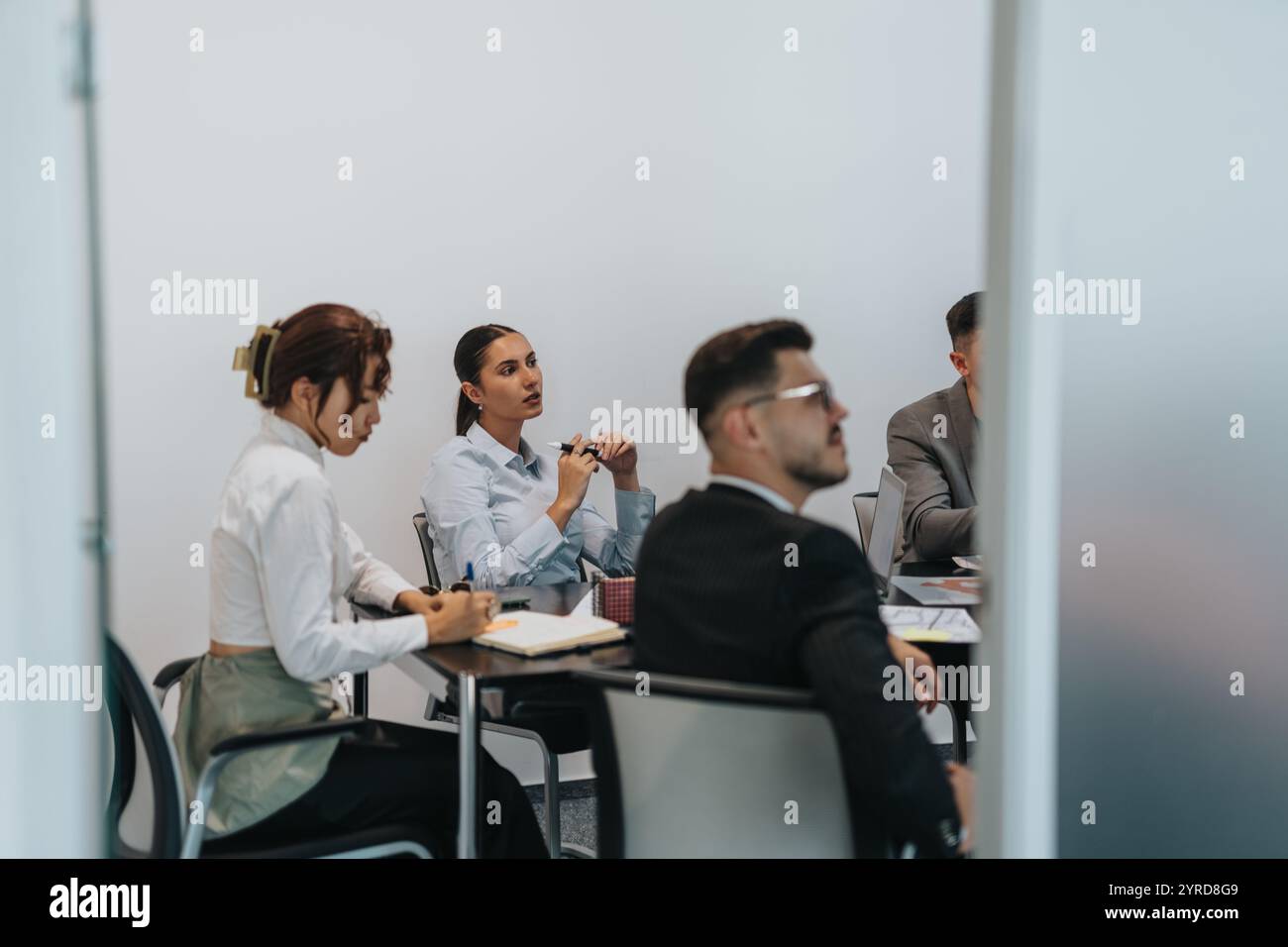 A group of diverse colleagues engaged in a brainstorming session in a ...