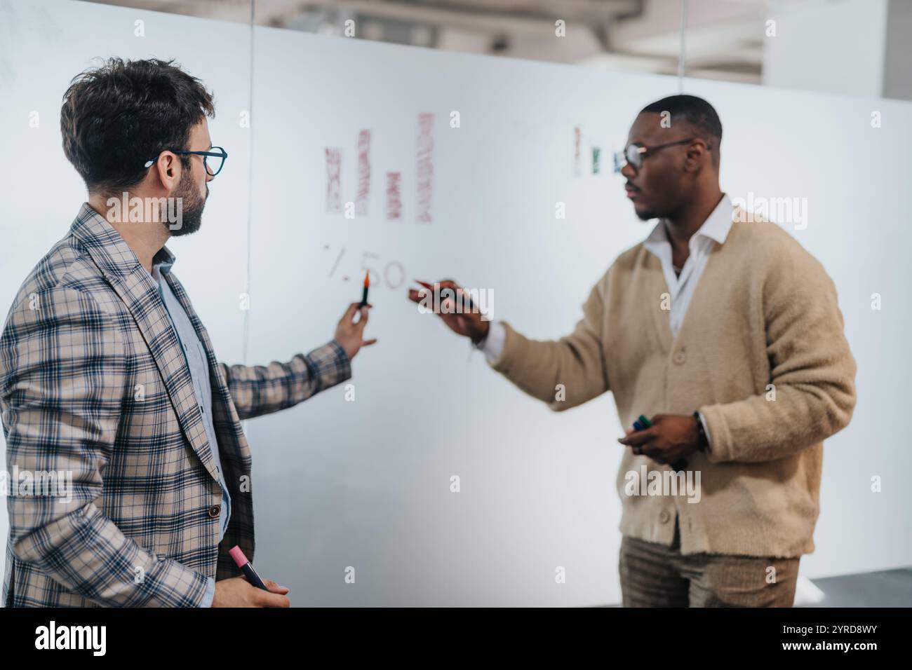Two colleagues engage in a collaborative brainstorming session ...